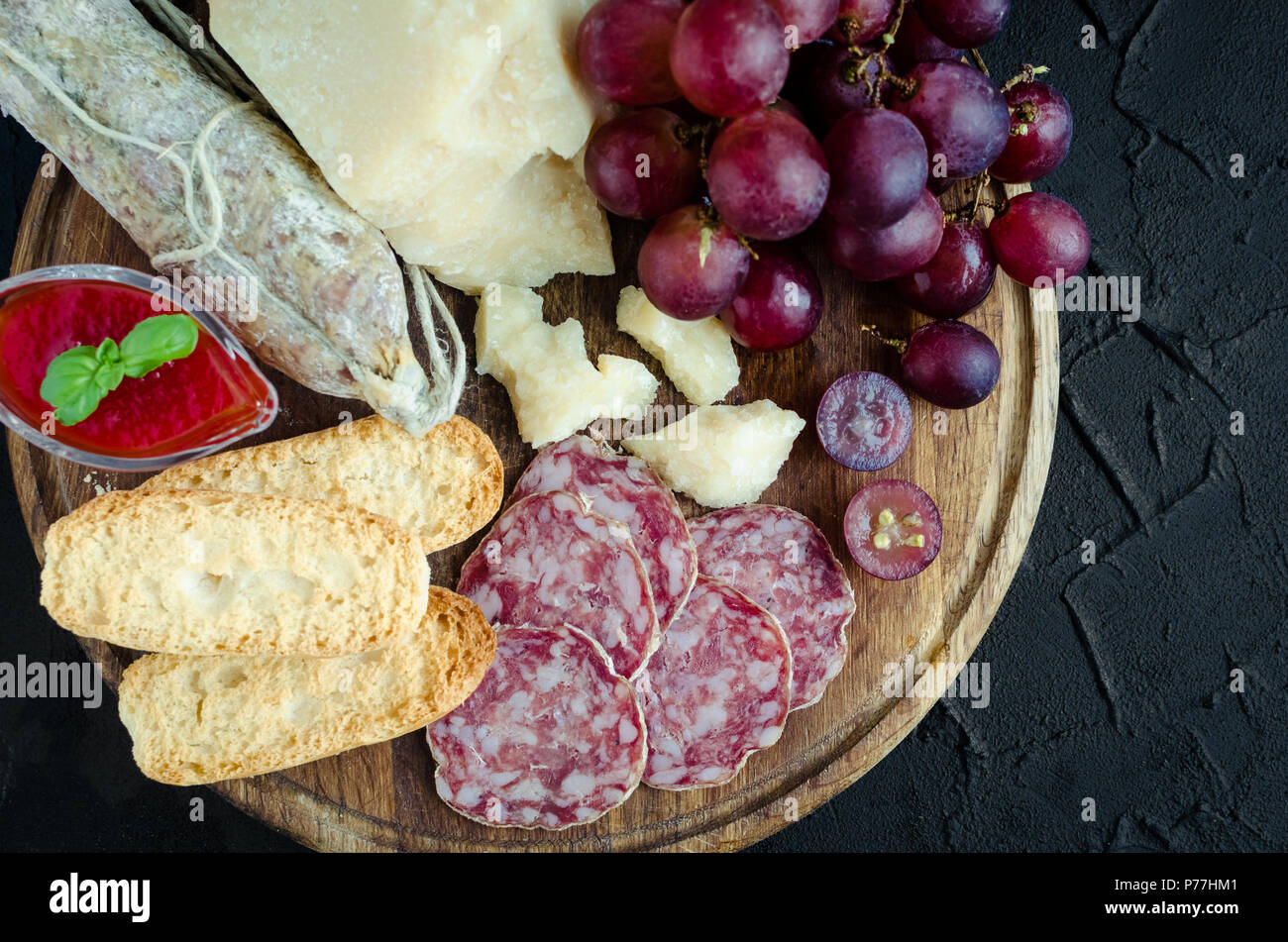 Board with mediterranean appetizers, tapas or antipasti. Assorted ...