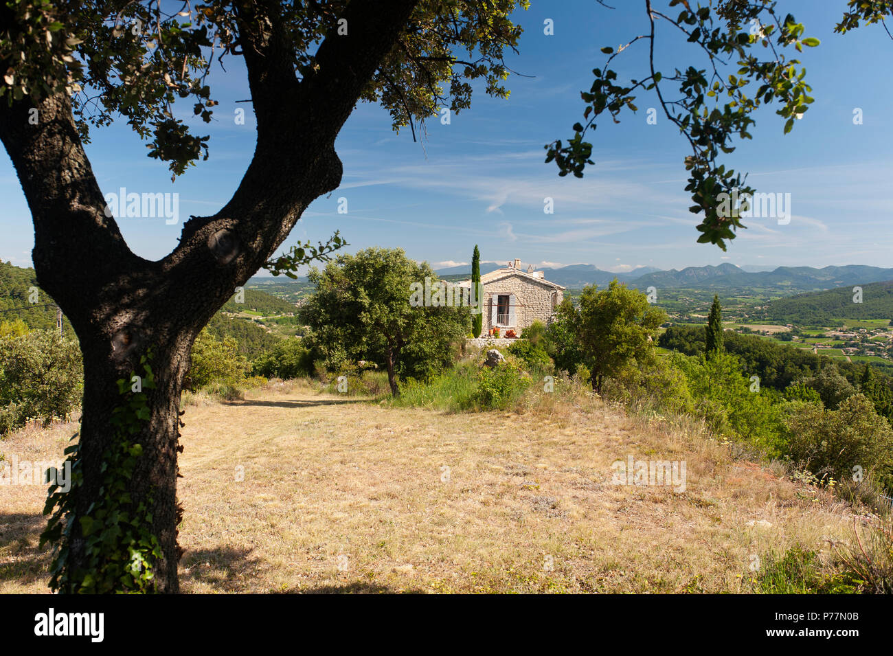 Stone house amongst trees Stock Photo - Alamy