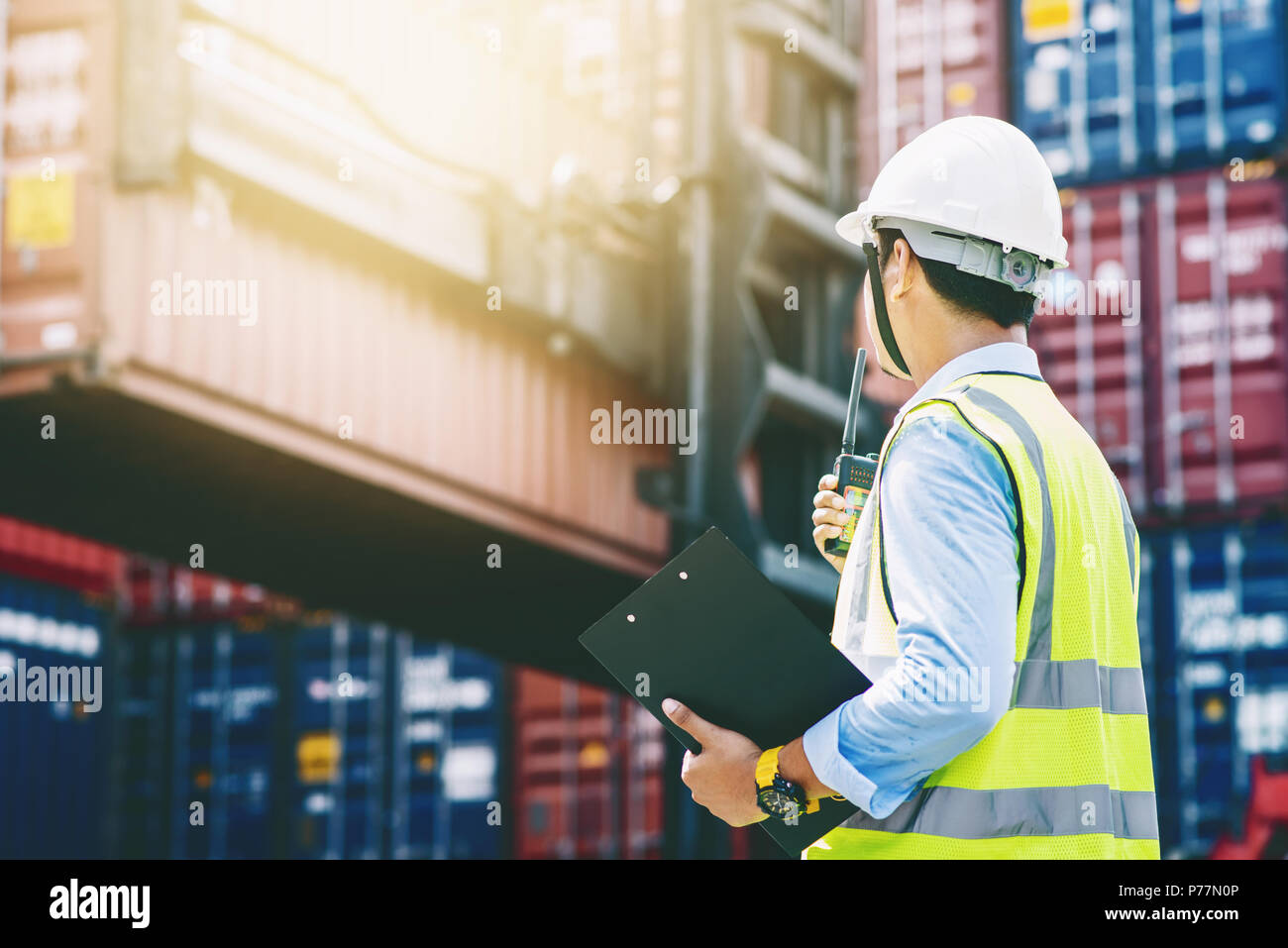 Foreman control loading Containers box from Cargo freight ship for ...