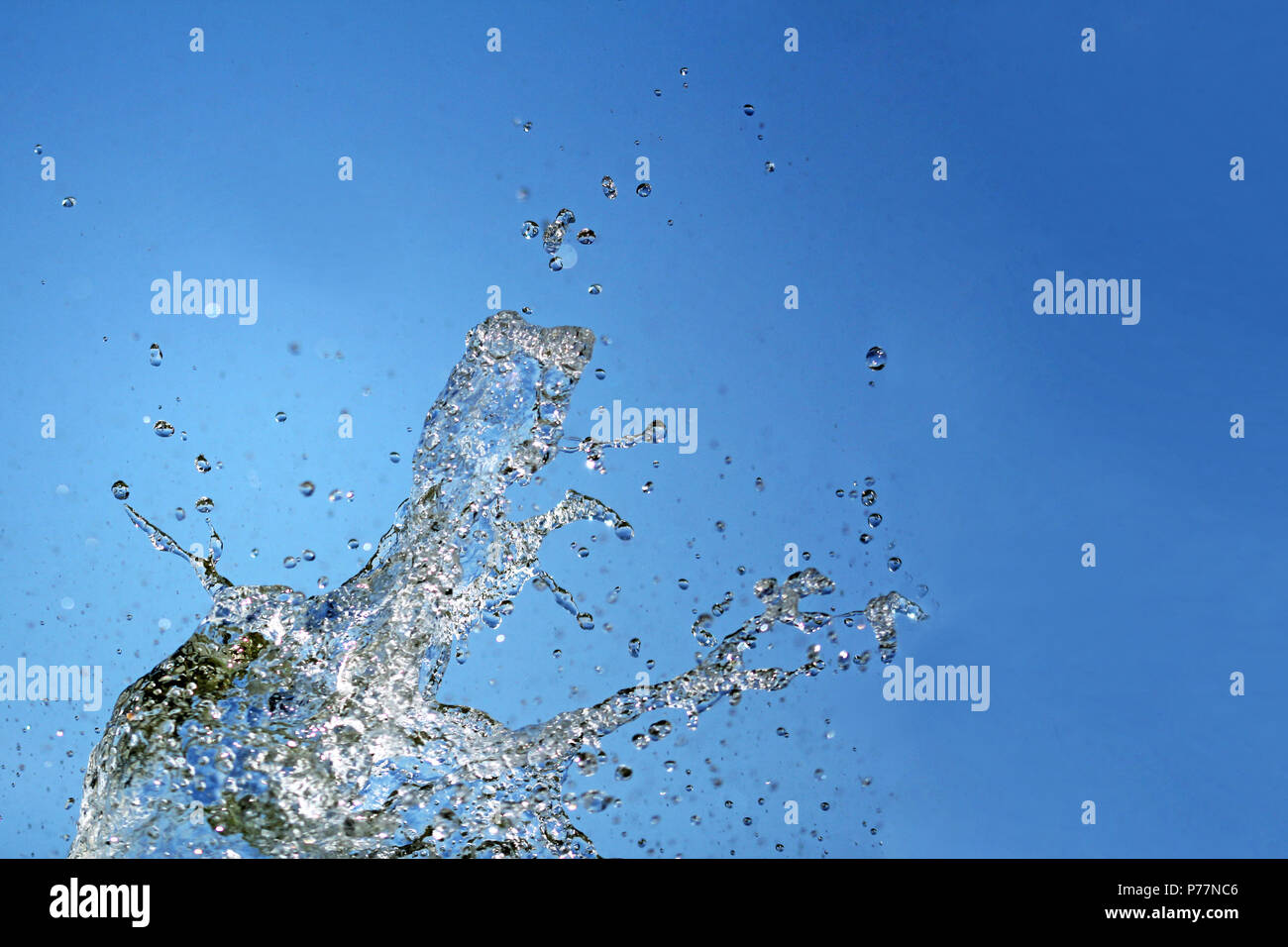 Water splash on blue background close up shoot Stock Photo - Alamy