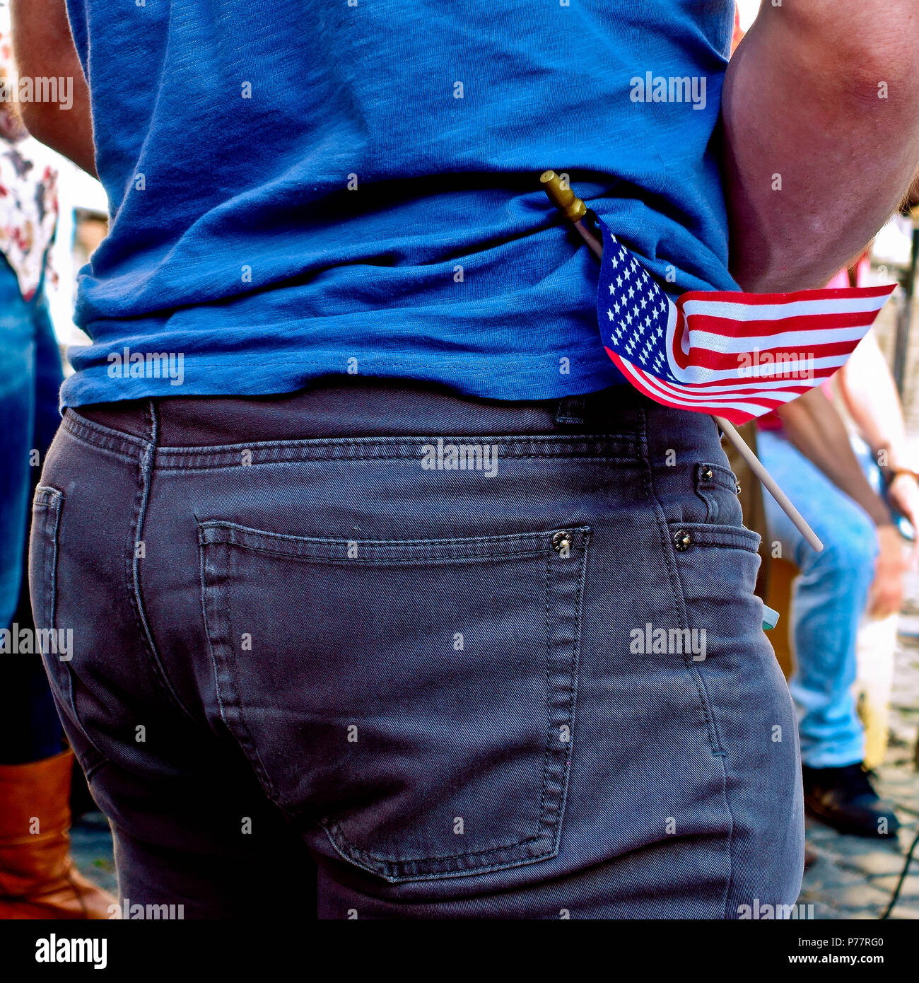 Attractive young man with an American flag inserted in the jeans ...