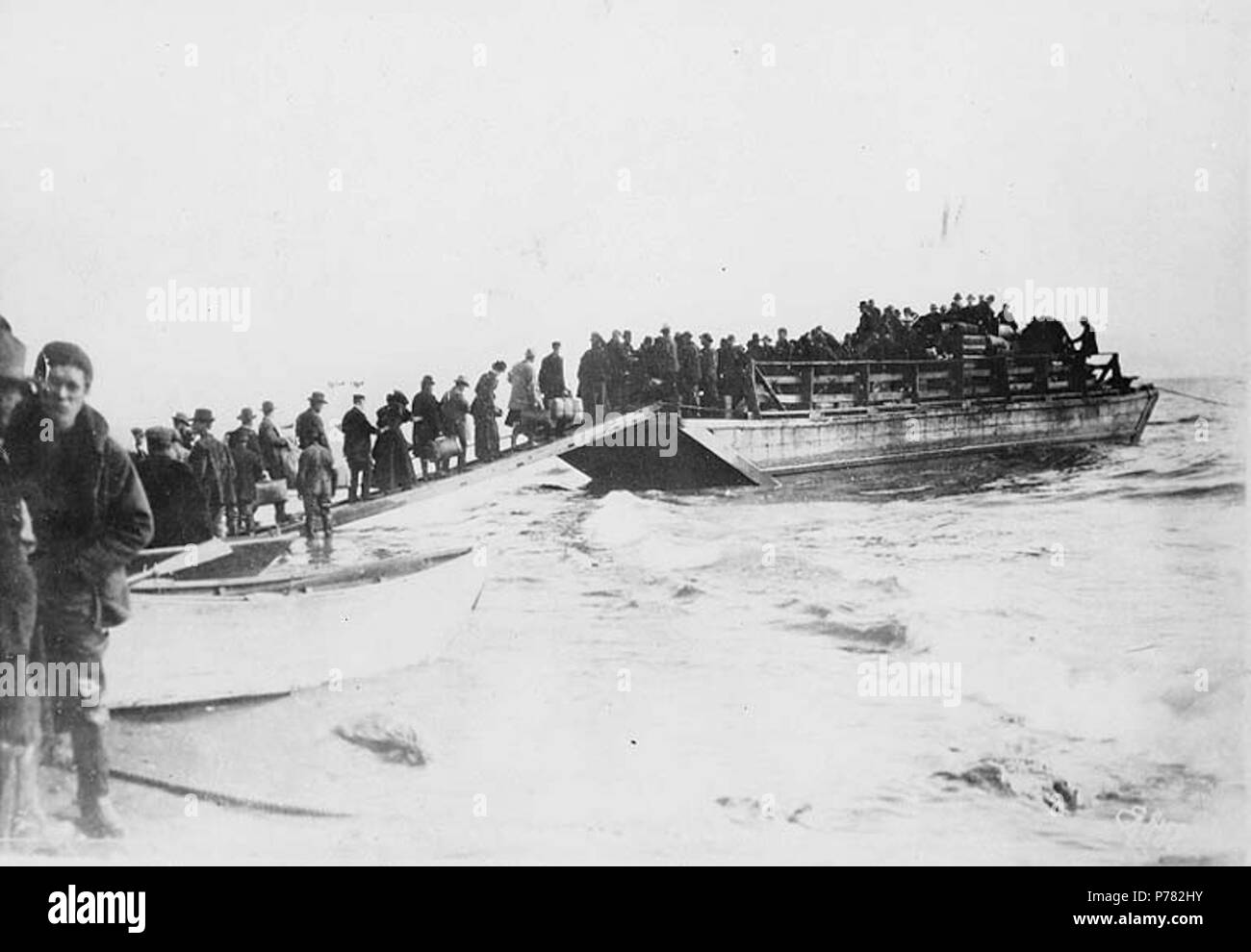 . English: People boarding scow on Nome beach, Alaska, ca. 1900 ...