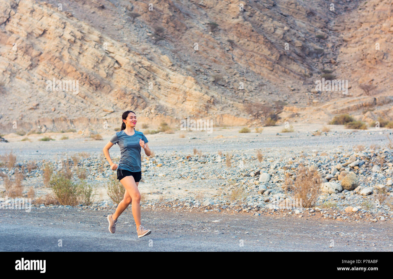 Female running in the desert road, outdoor workout Stock Photo - Alamy