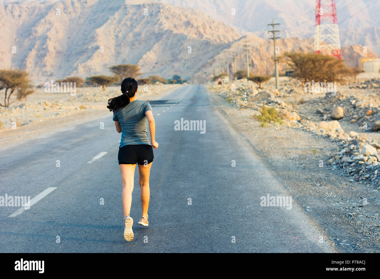 Female runner on the desert road, outdoor workout Stock Photo - Alamy