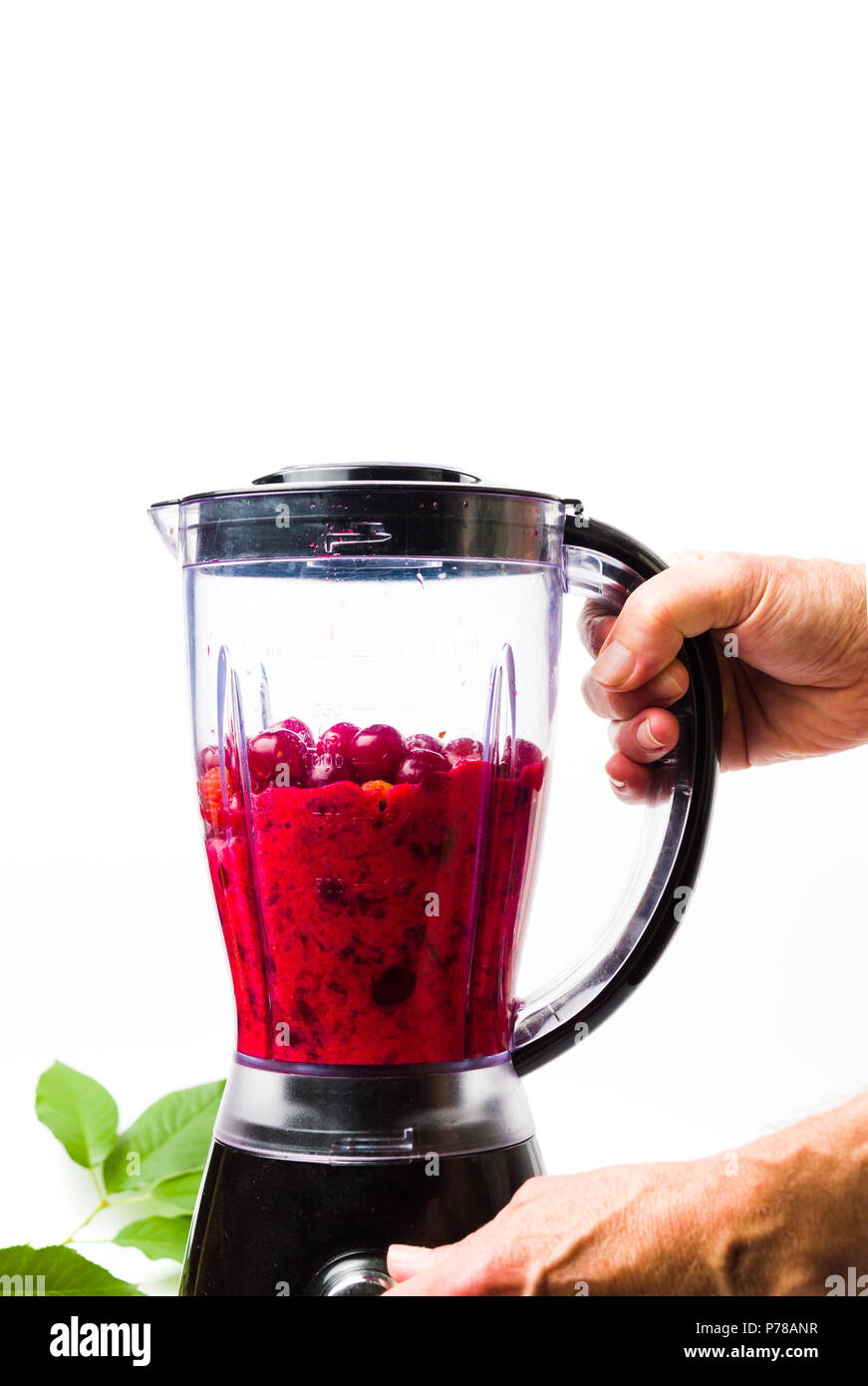 Person making cherry smoothie with a blender isolated Stock Photo - Alamy