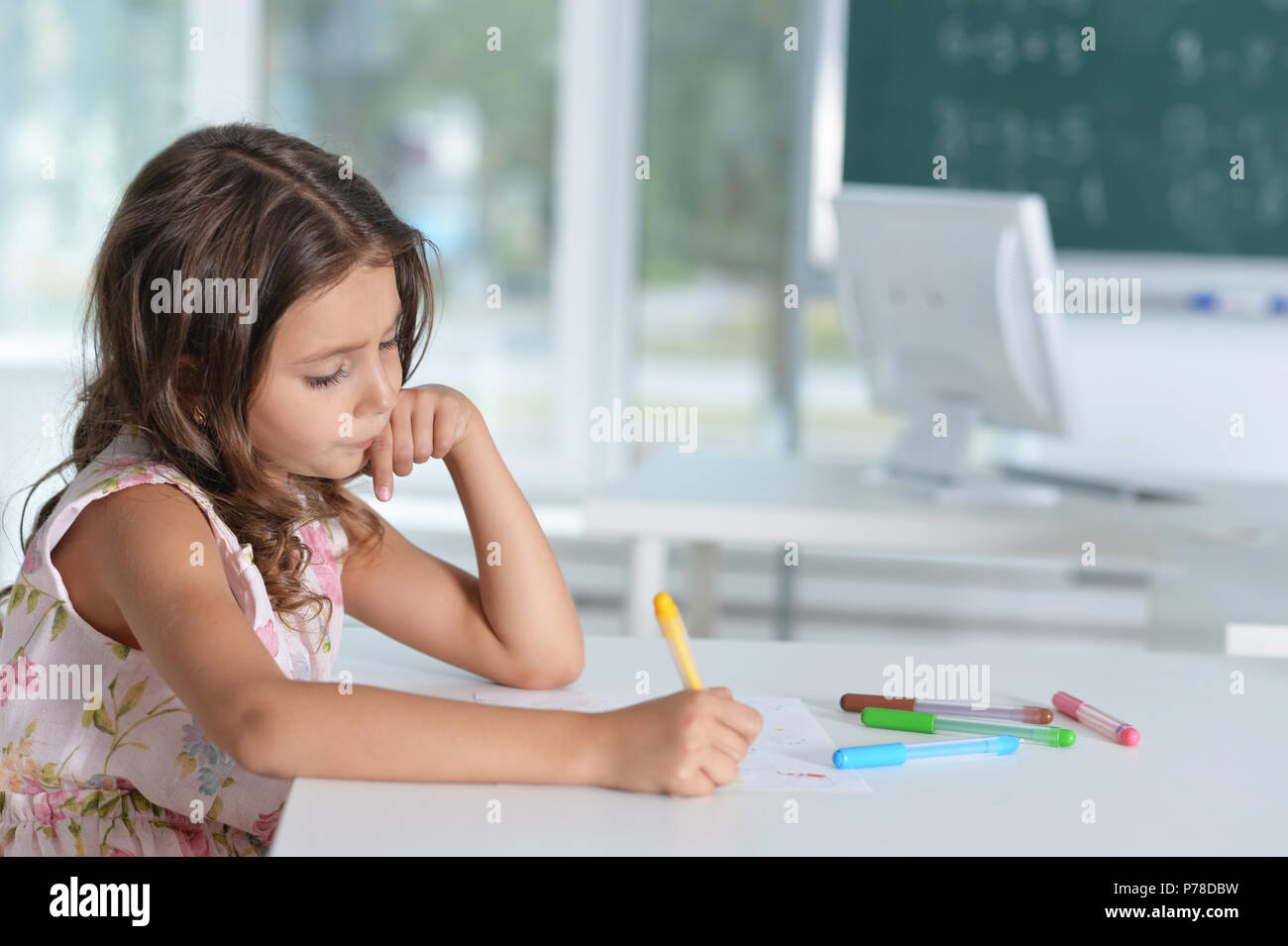 Cute little girl doing homework Stock Photo - Alamy
