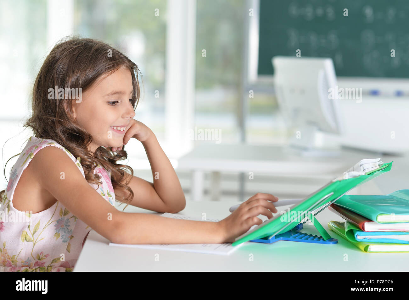 Cute little girl doing homework Stock Photo - Alamy