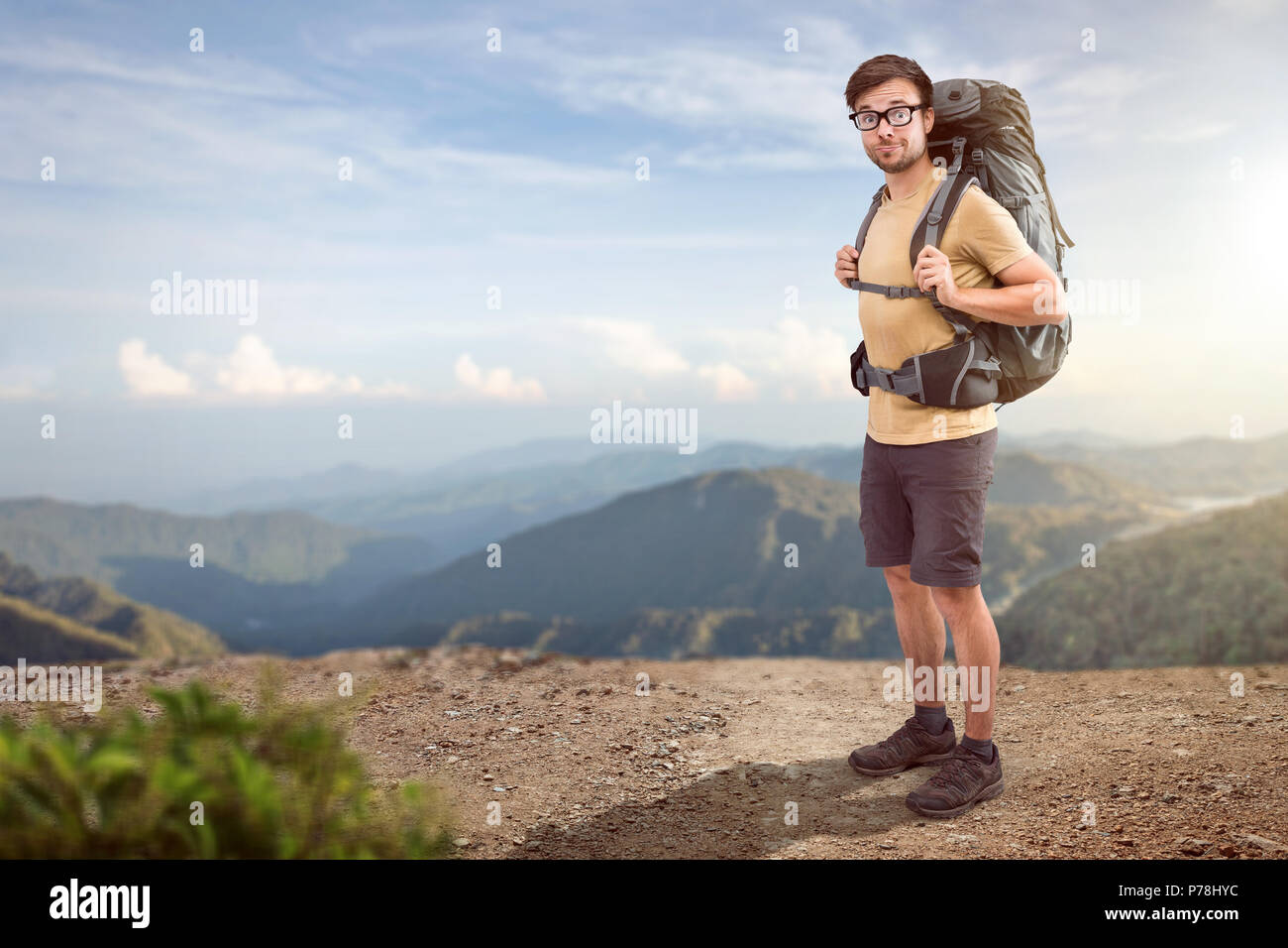 Backpacker in front of a tropical mountain view Stock Photo - Alamy
