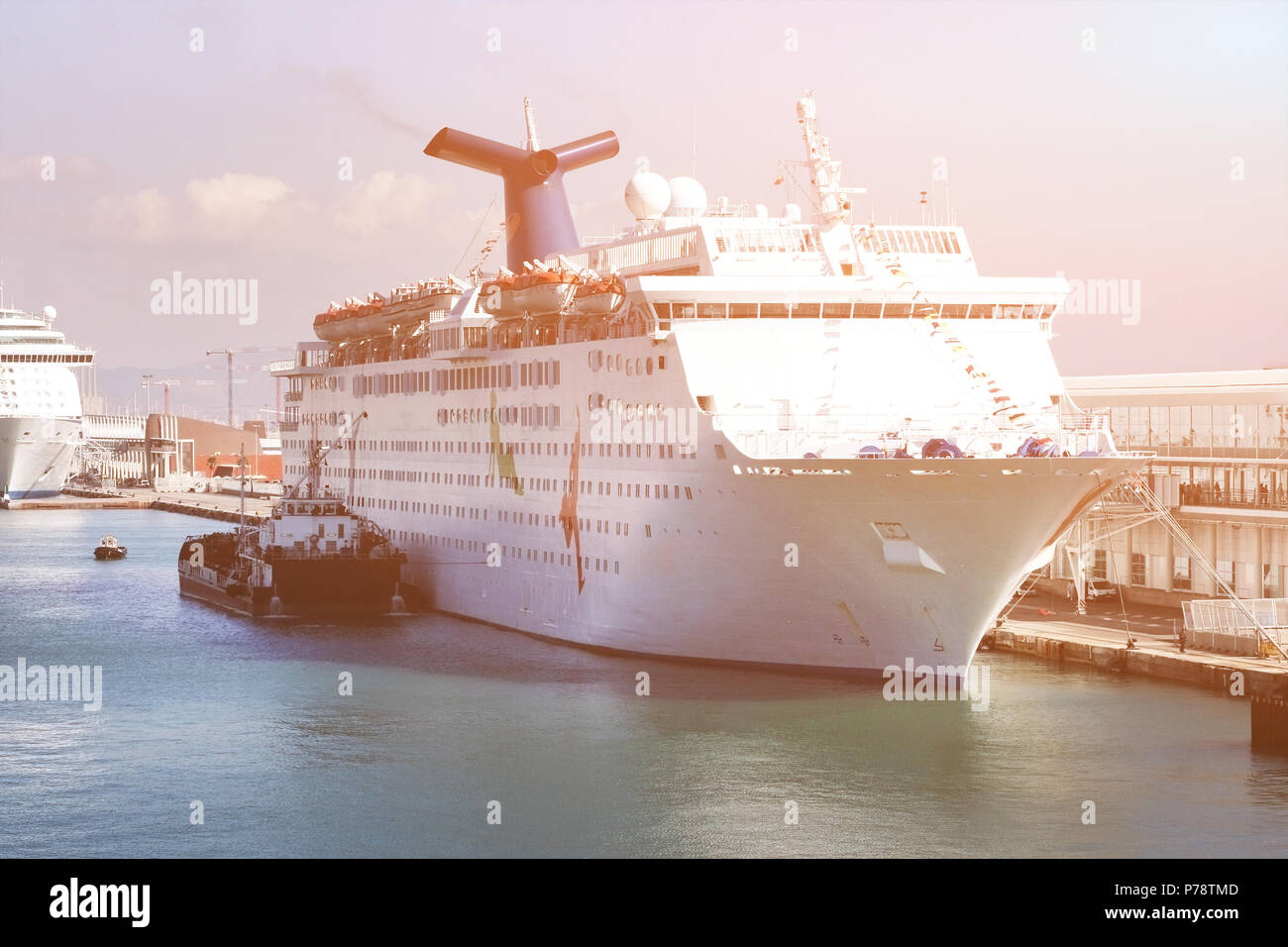 Delivering ship refueling big white passenger cruise liner. Refueling ...