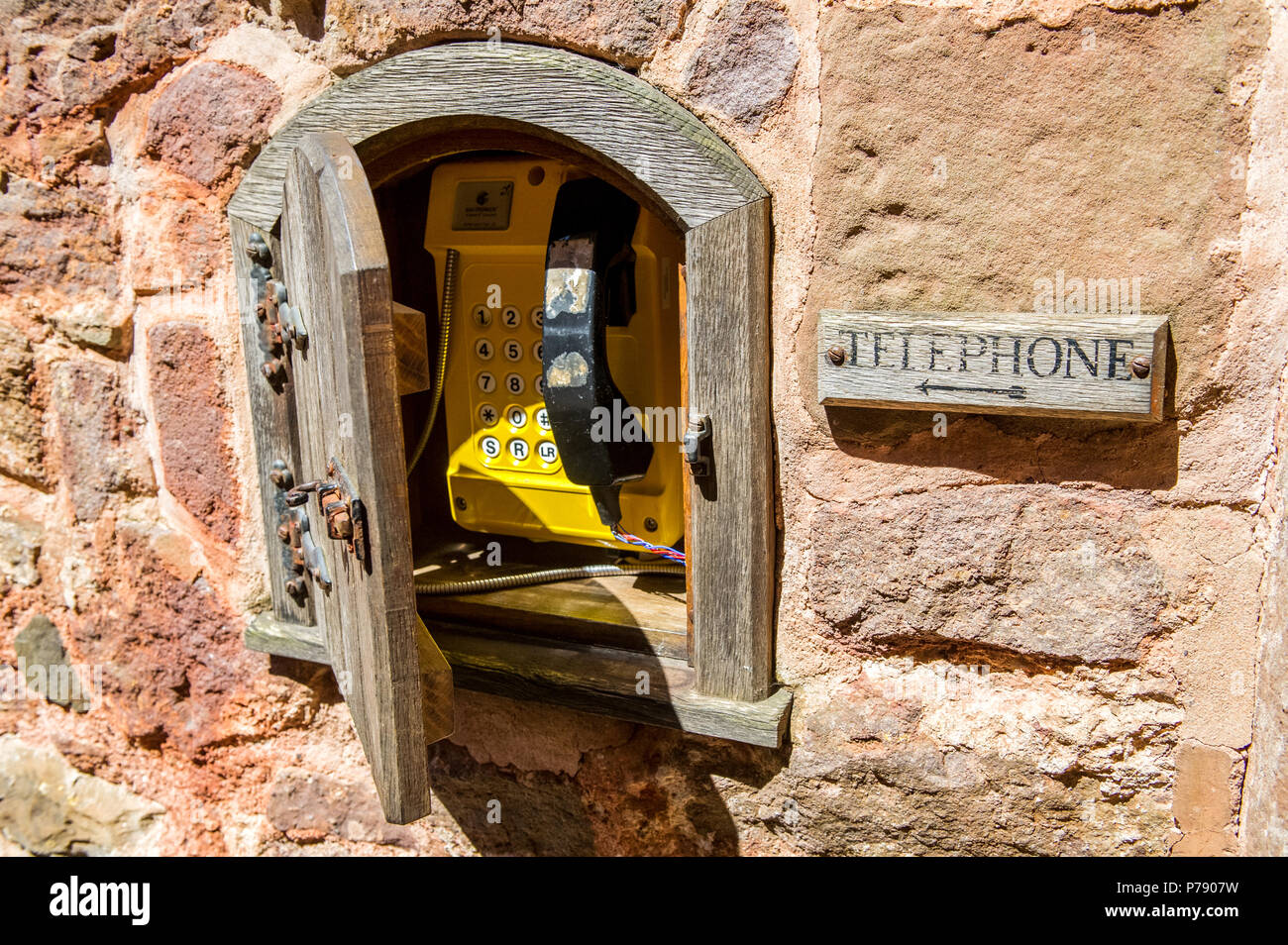 Yellow telephone in an ornate oak telephone box Stock Photo - Alamy