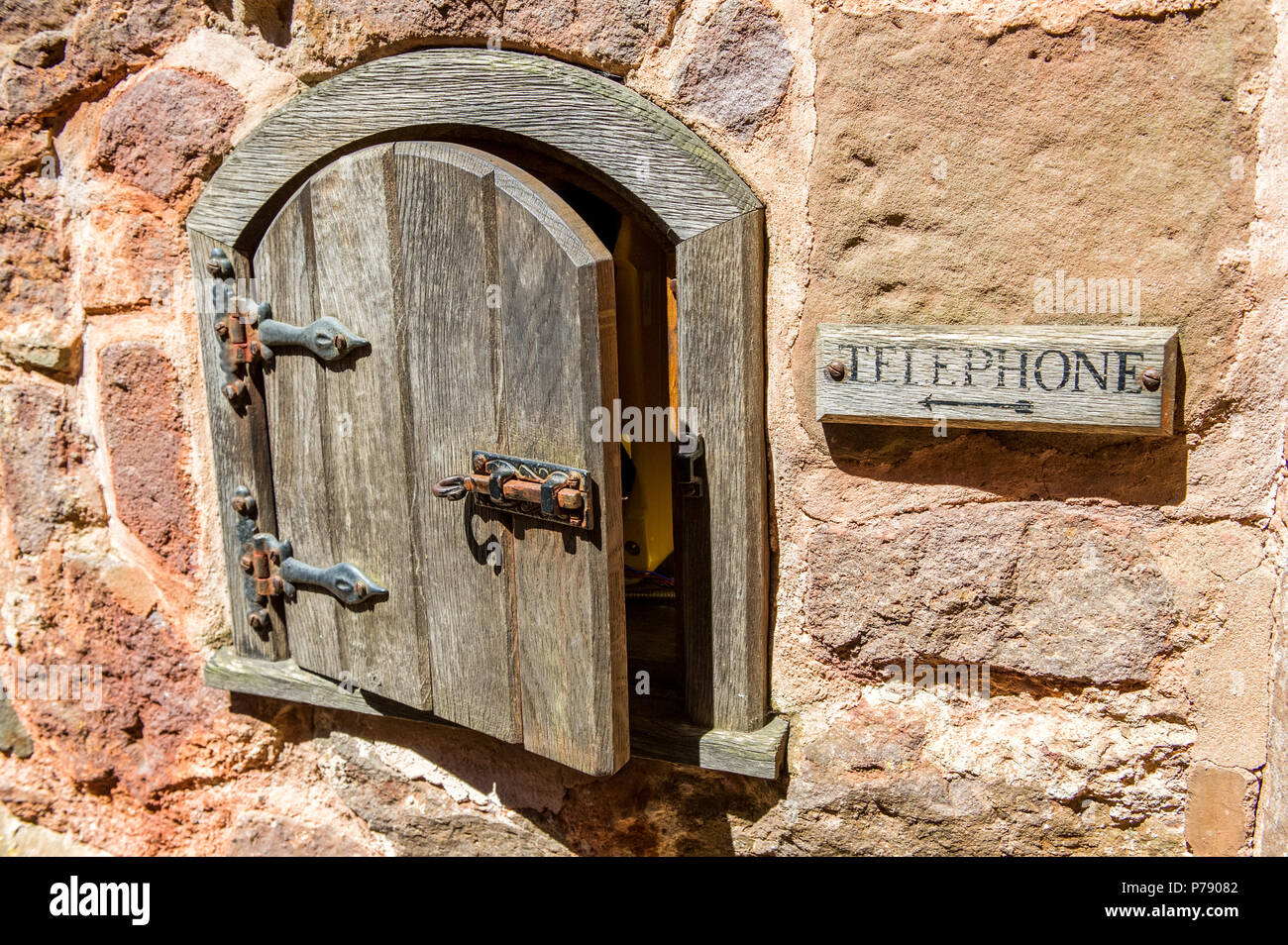 Yellow telephone in an ornate oak telephone box Stock Photo - Alamy