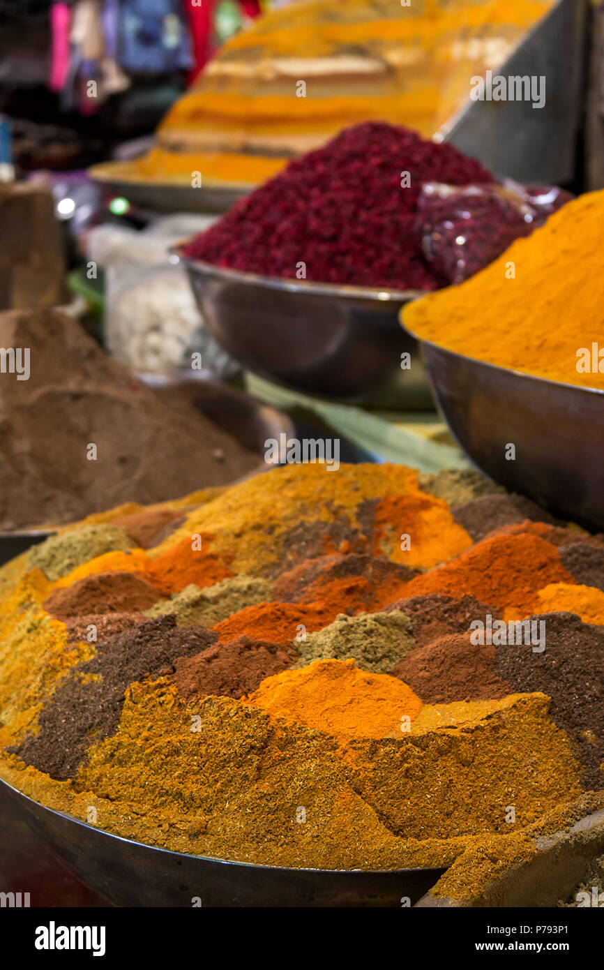 A colourful display of layered and sectioned cooking powders and spices ...
