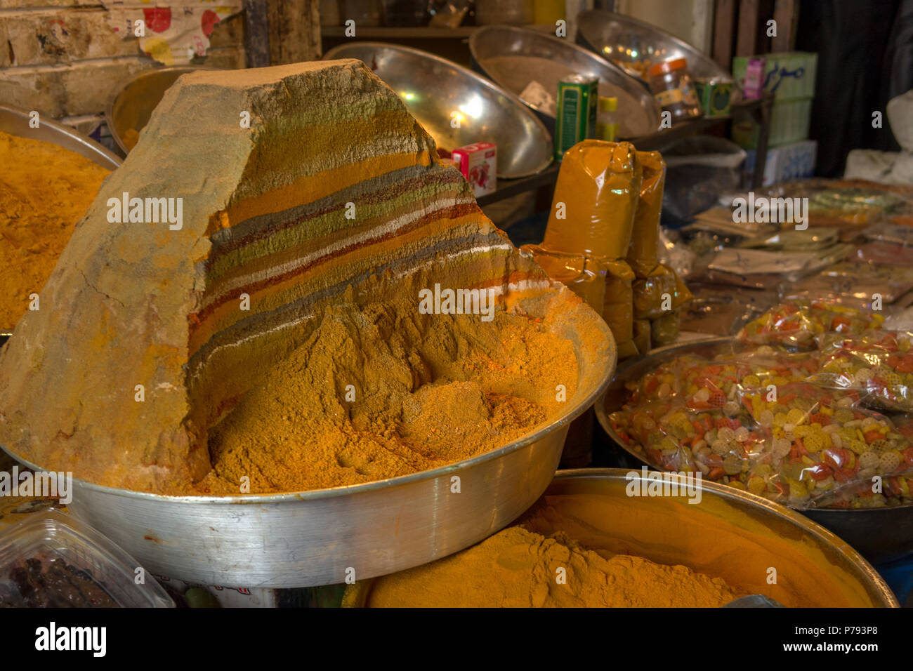 A colourful display of layered and sectioned cooking powders and spices ...