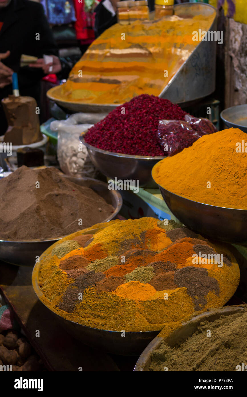 A colourful display of layered and sectioned cooking powders and spices ...
