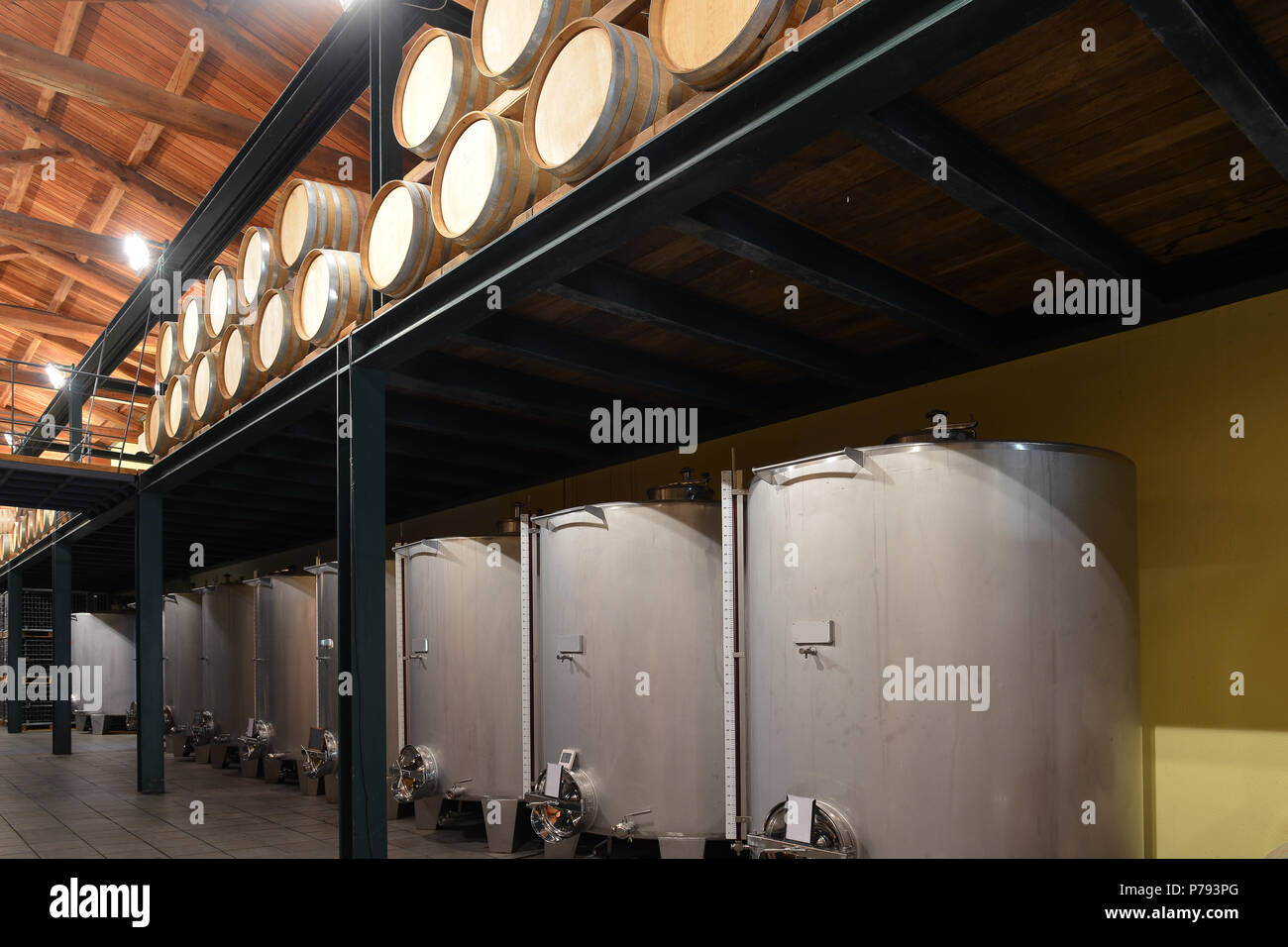 Stainless steel wine vats in a row inside the winery Stock Photo - Alamy