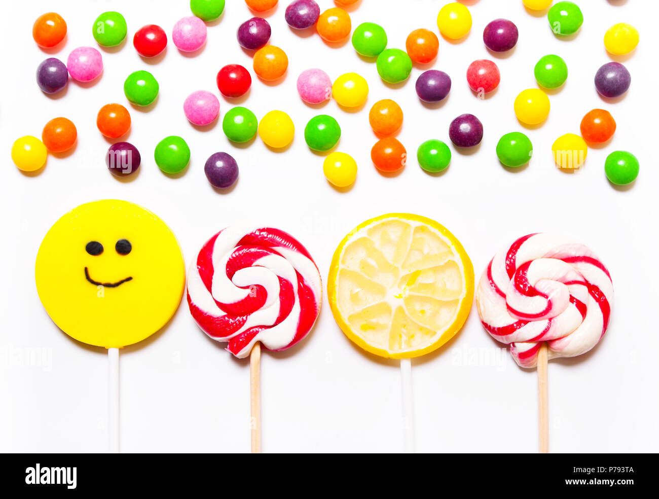 Lollipops, candy smile on, are scattered around the colorful jelly ...