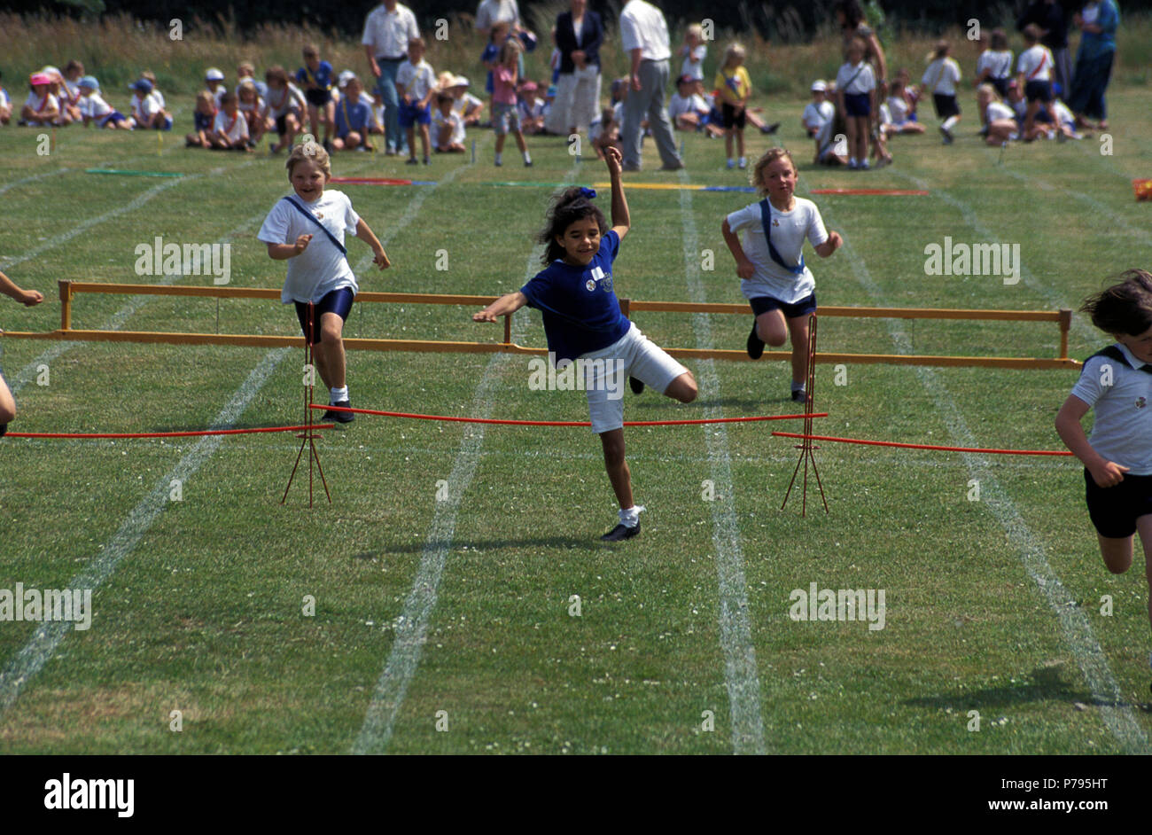 primary school sports day, children jumping hurdles Stock Photo - Alamy