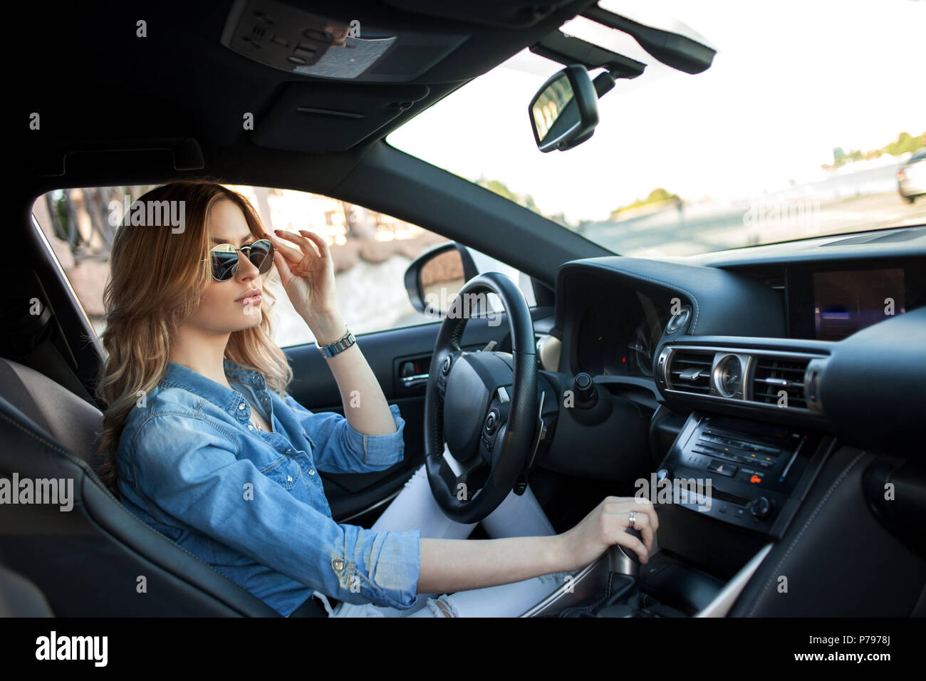 Young attractive woman driving her car. Portrait of a successful ...