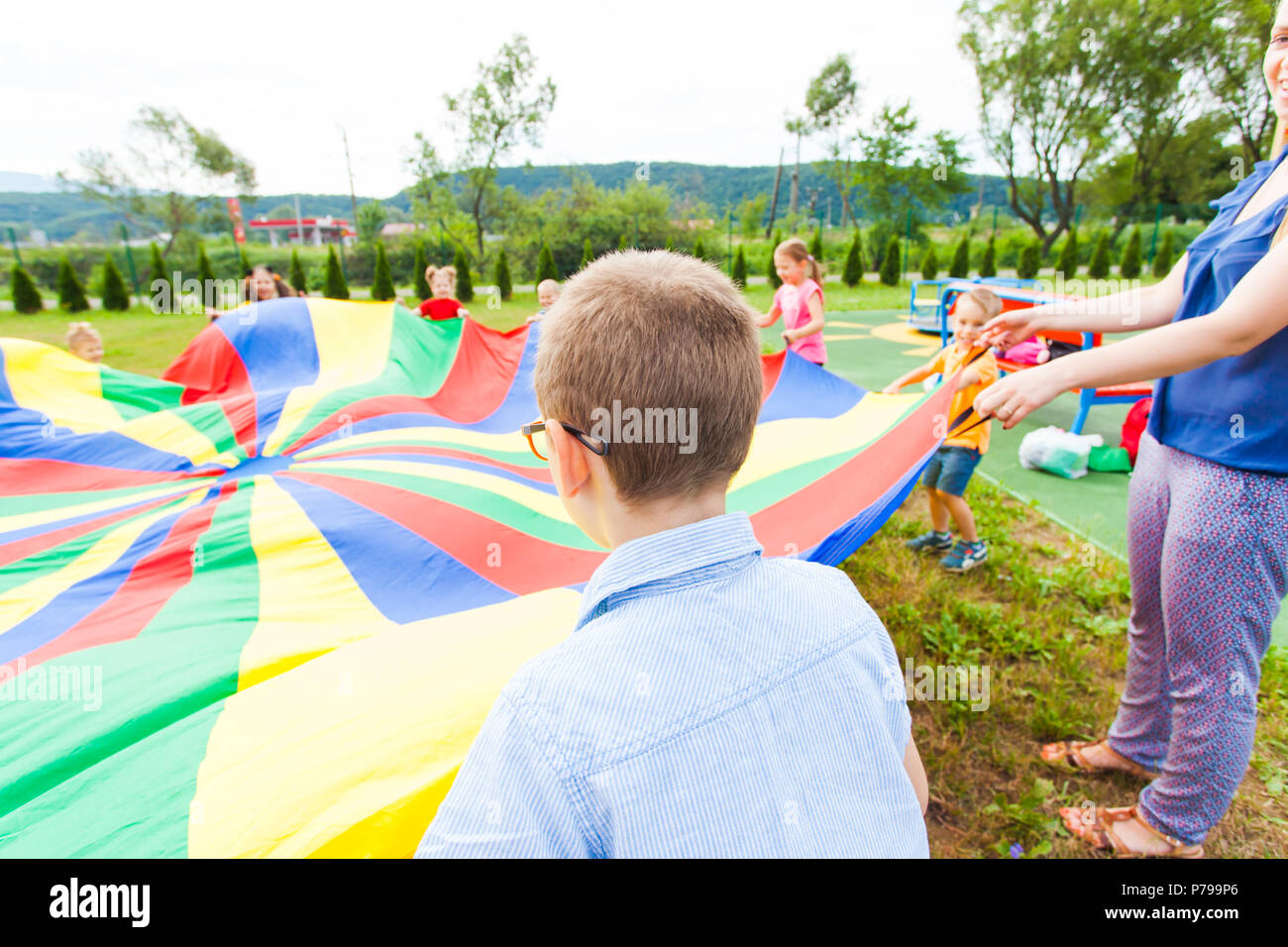Kid in a parachute hi-res stock photography and images - Alamy