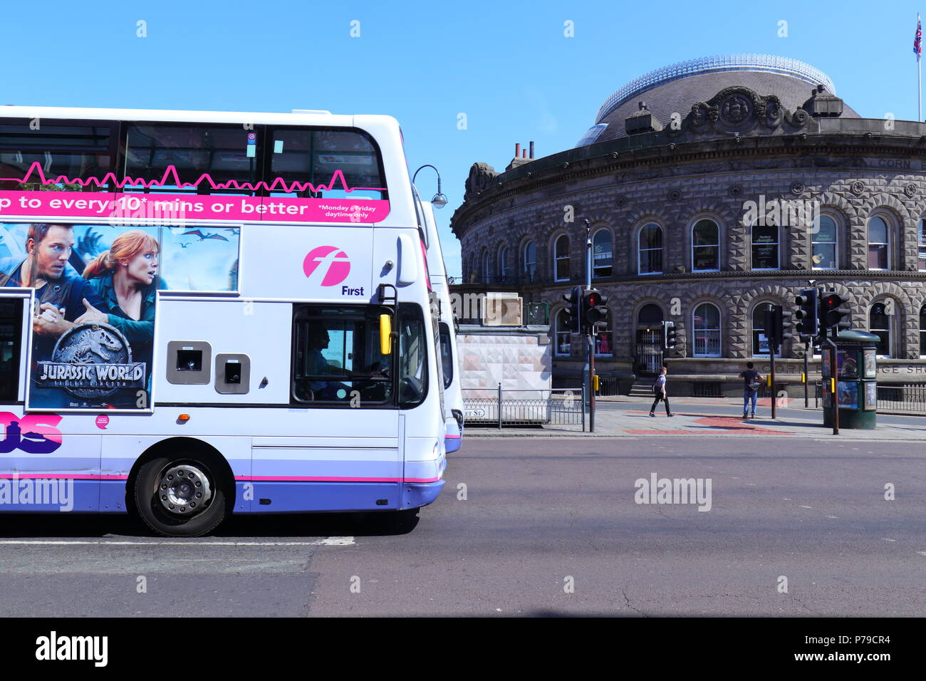 A bus stops at red lights outside Leeds Corn Exchange which is an ...
