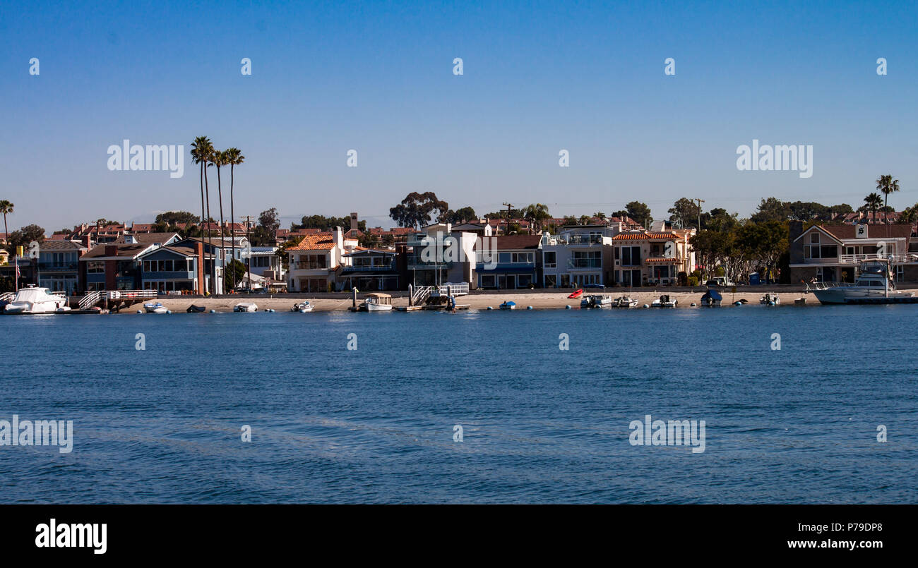 Balboa island bay front skyline in Newport Beach California on a sunny ...