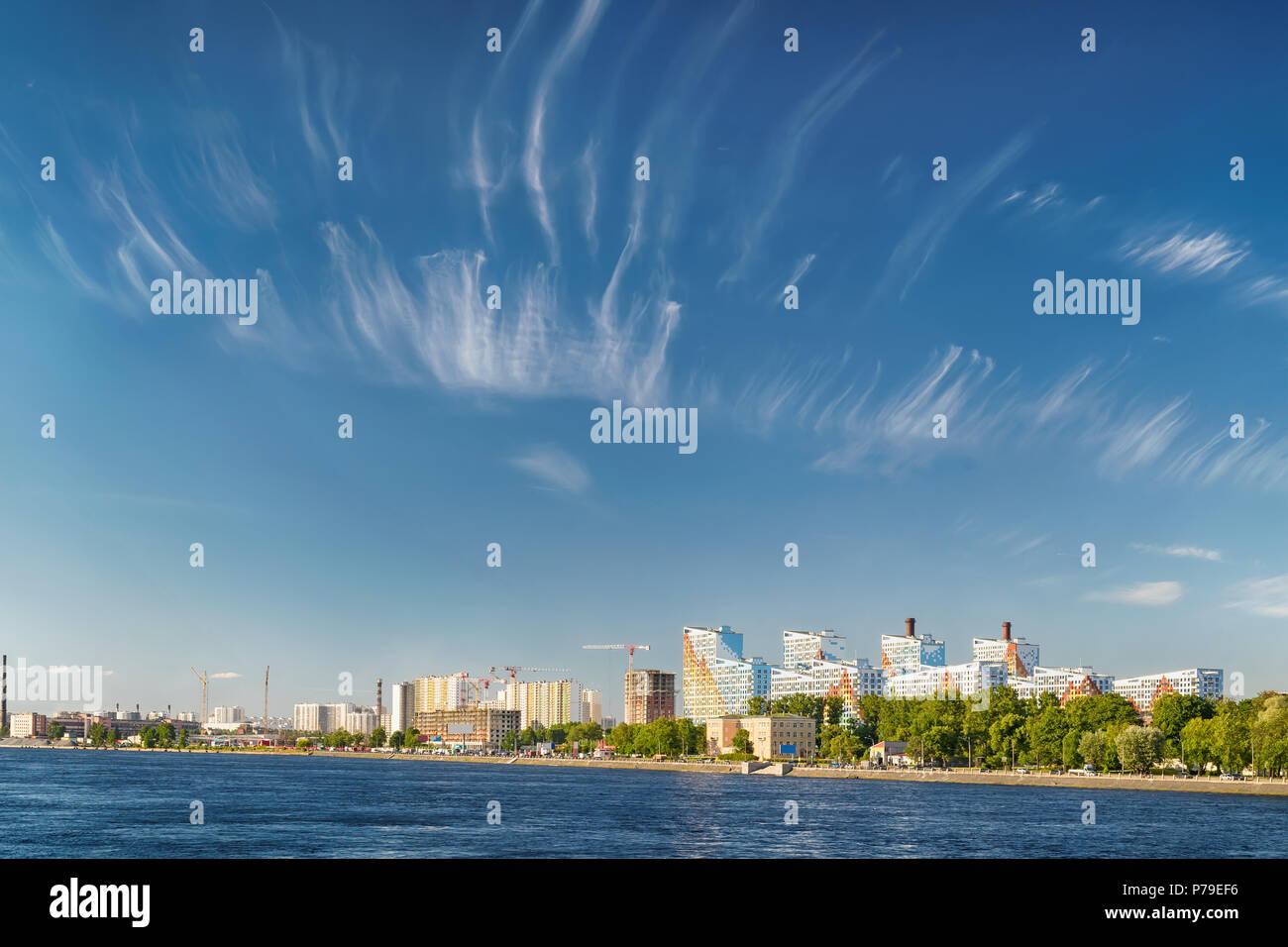 Bright summer urban riverside panoramic landscape with new buildings ...