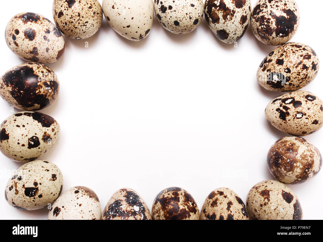 square frame of quail eggs on a white background. View from above, flat ...