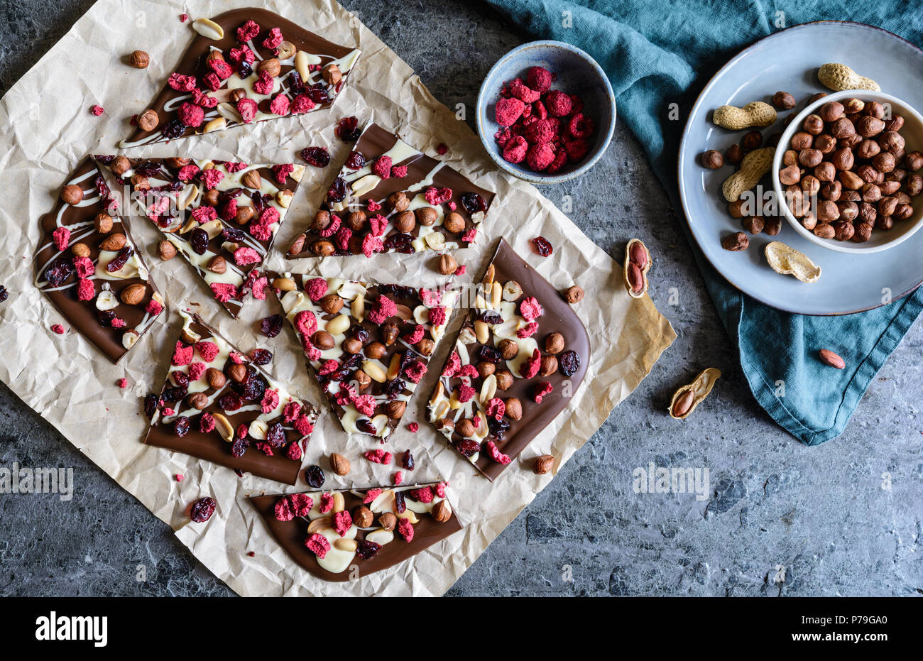 Homemade chocolate bark with hazelnuts, peanuts, cranberries and freeze ...