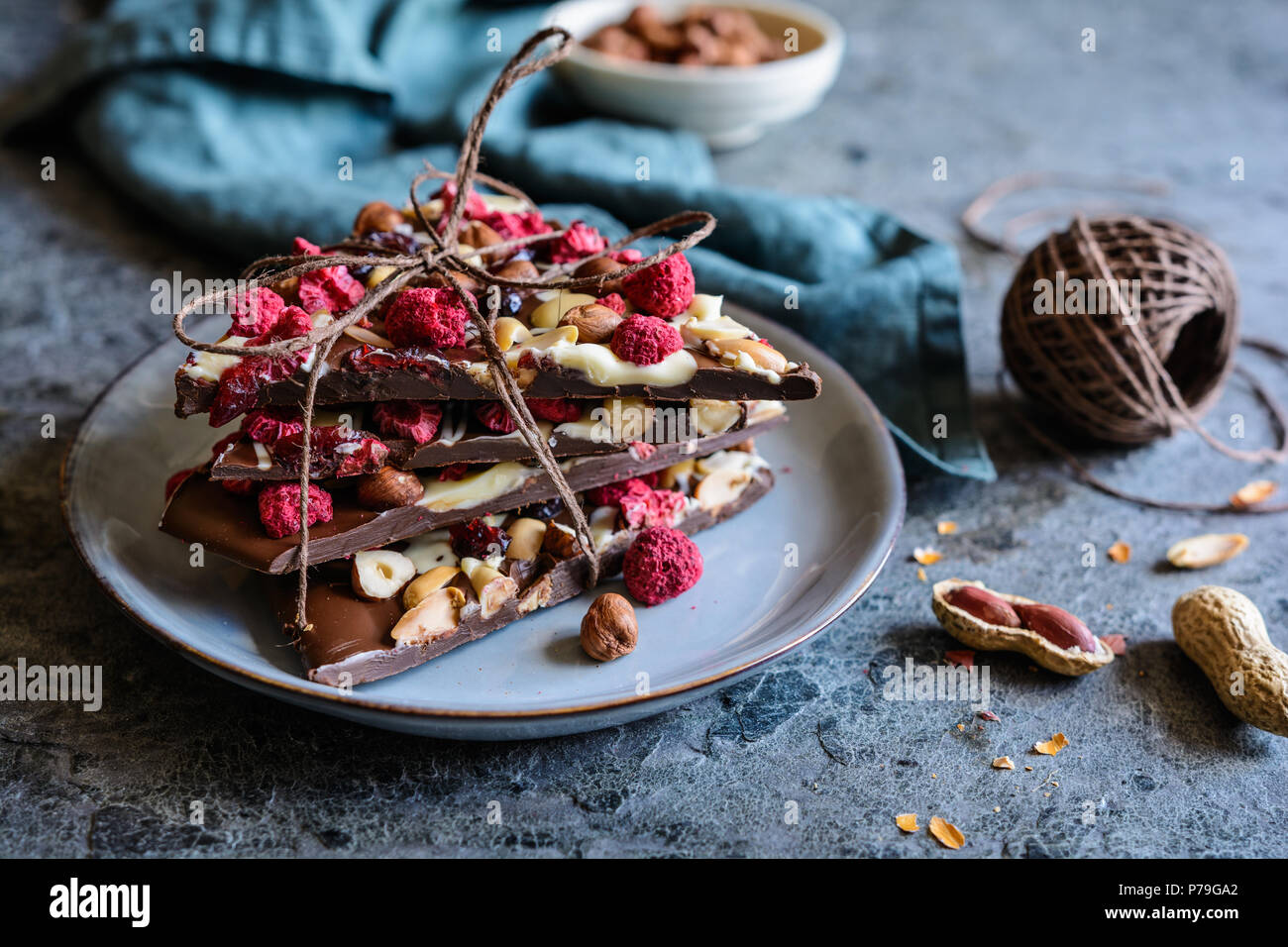 Homemade chocolate bark with hazelnuts, peanuts, cranberries and freeze ...