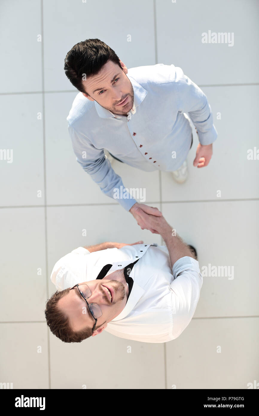 top view. business partners shake hands and look at the camera Stock ...