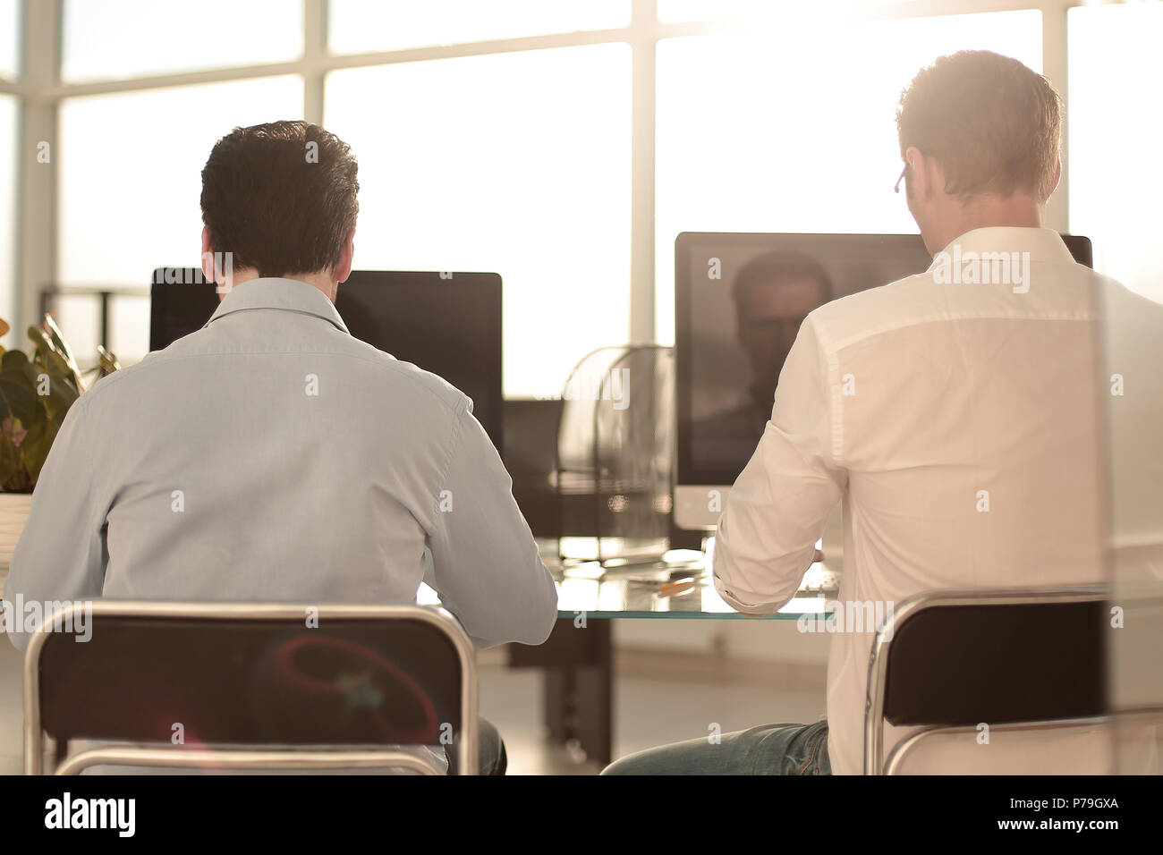 rear view.two business people working at the Desk Stock Photo - Alamy