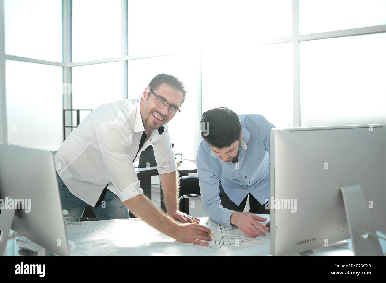 Smiling architects work drawings hi-res stock photography and images ...