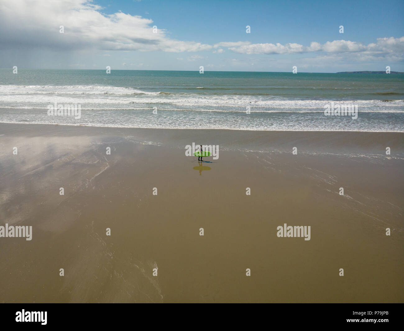Surfer with surfboard walking on the beach Stock Photo - Alamy