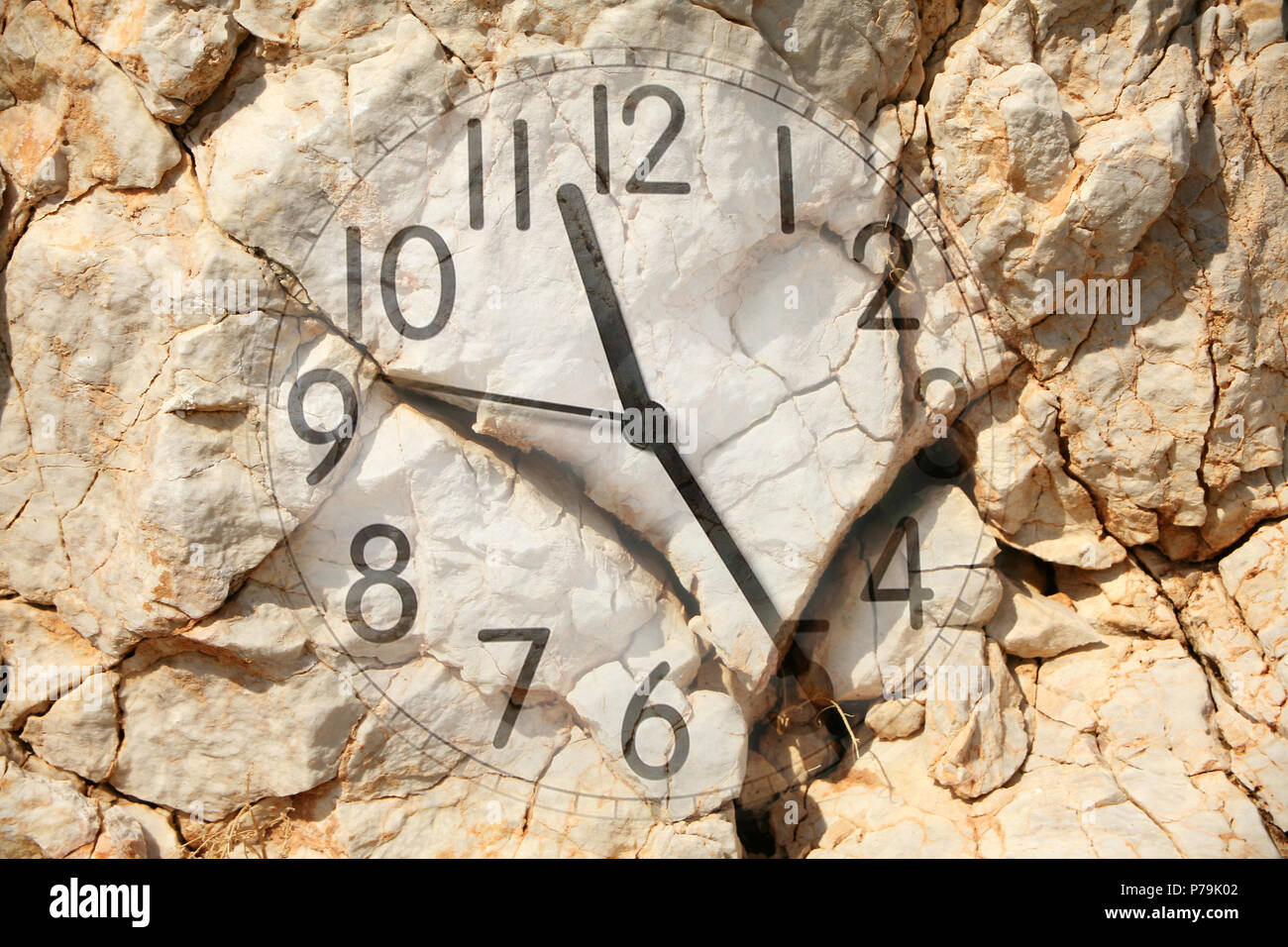 an image of a clock on rock background Stock Photo - Alamy