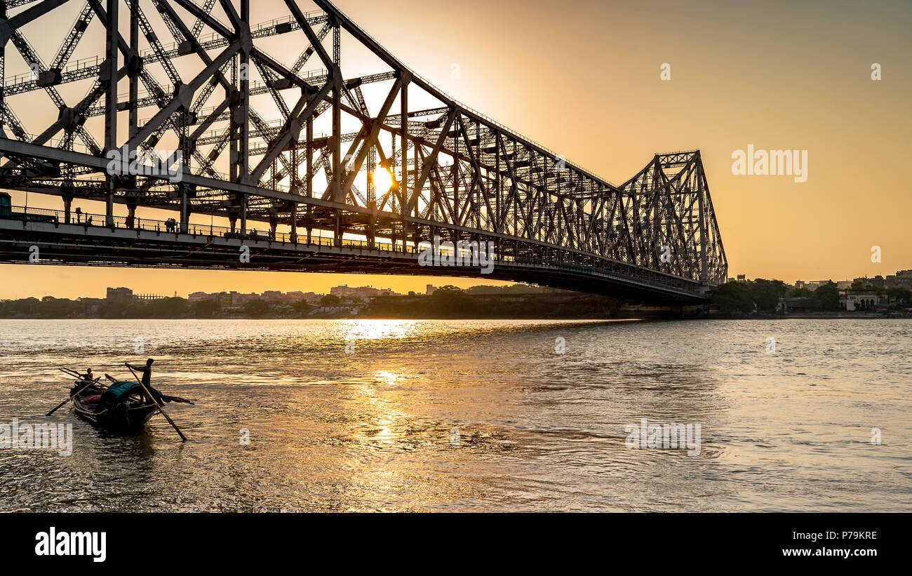 Silhouette of Howrah Bridge at the time of Sunrise. Howrah Bridge is a ...