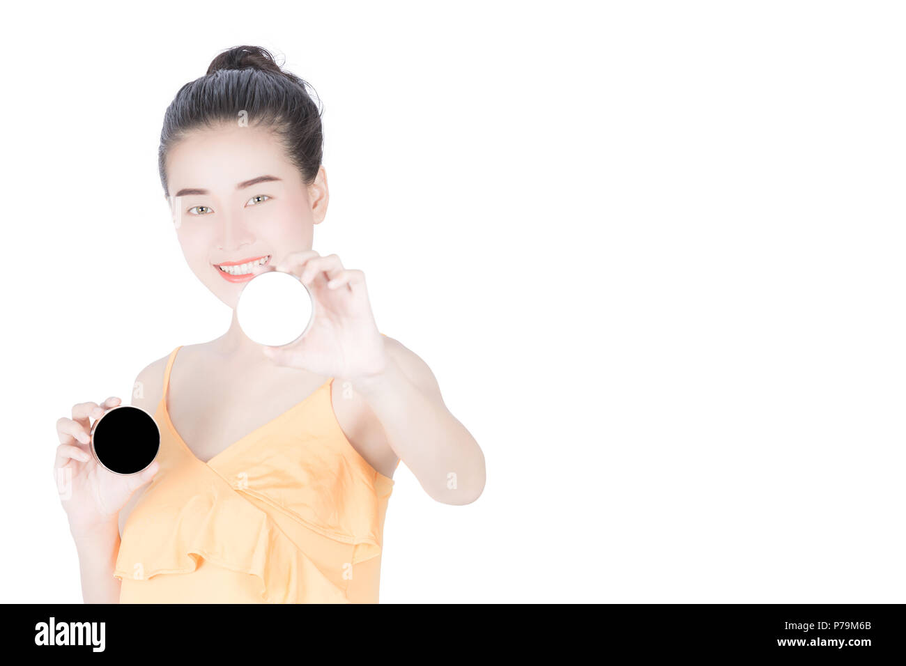 Girl holds the product for presentation. Lady beautiful in yellow shirt ...