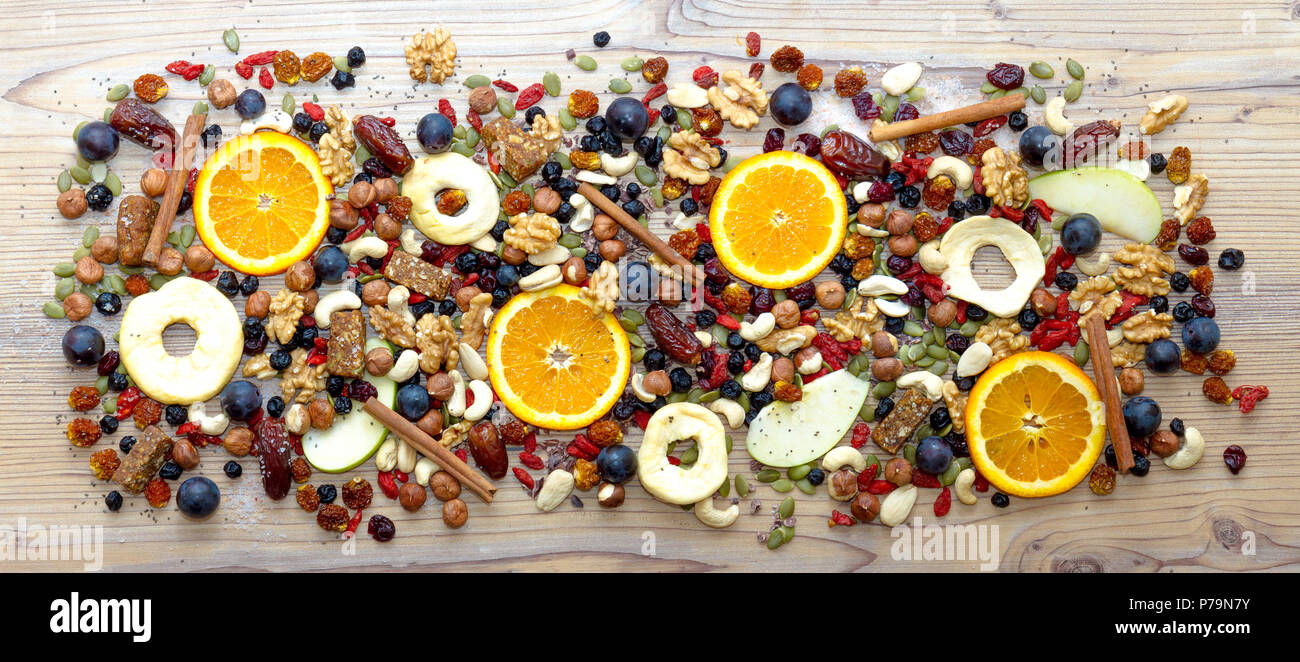Mix of dried fruits, nuts and healthy raw snack bars background texture ...