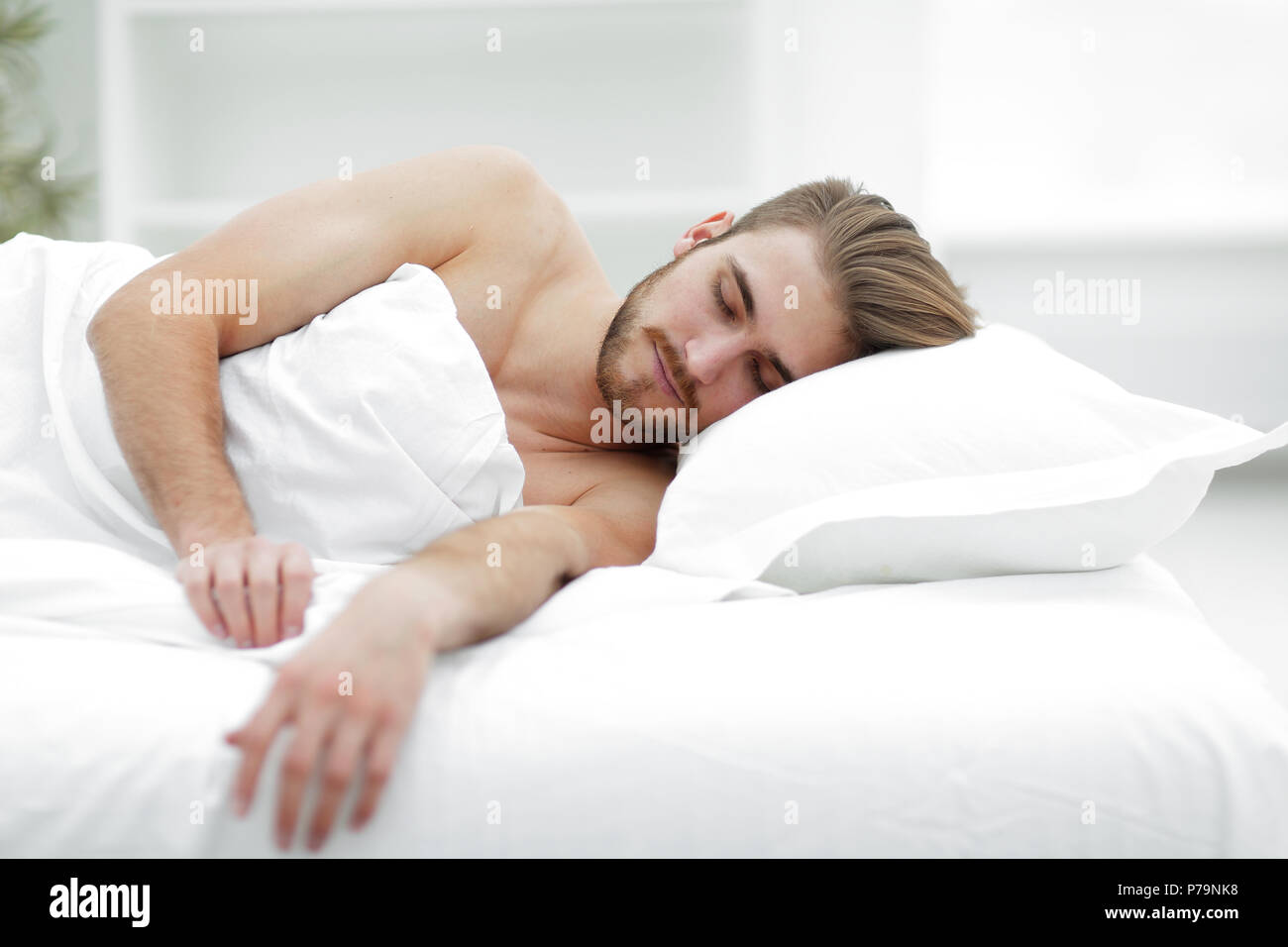 smiling man sleeping on a comfortable bed Stock Photo - Alamy