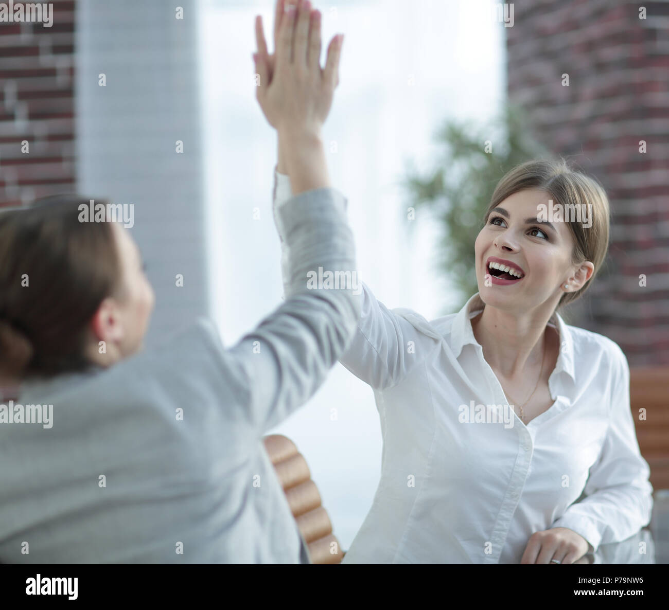 members of the business team giving each other a high five Stock Photo ...