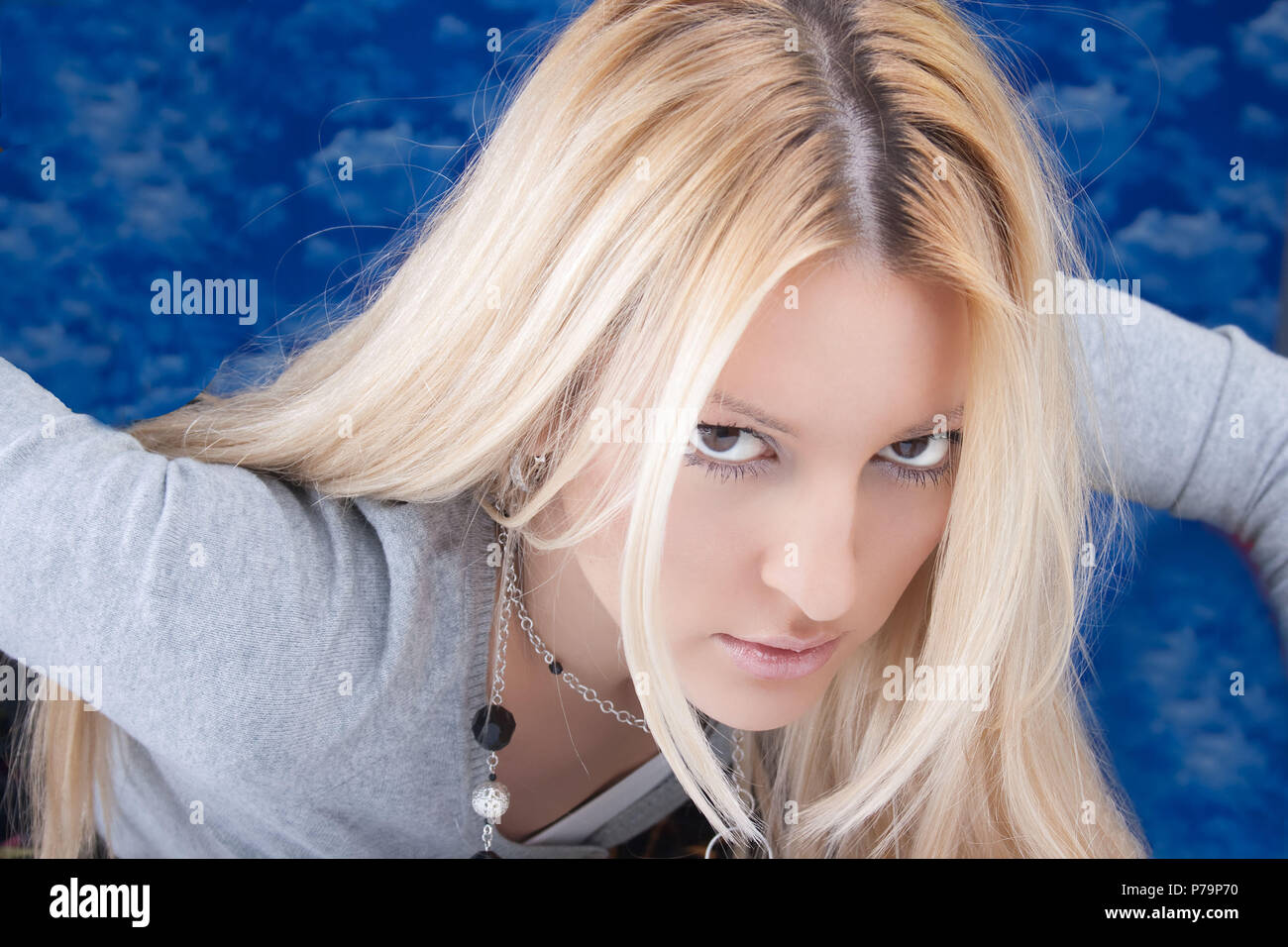 Young beautiful girl crouch on a floor Stock Photo - Alamy