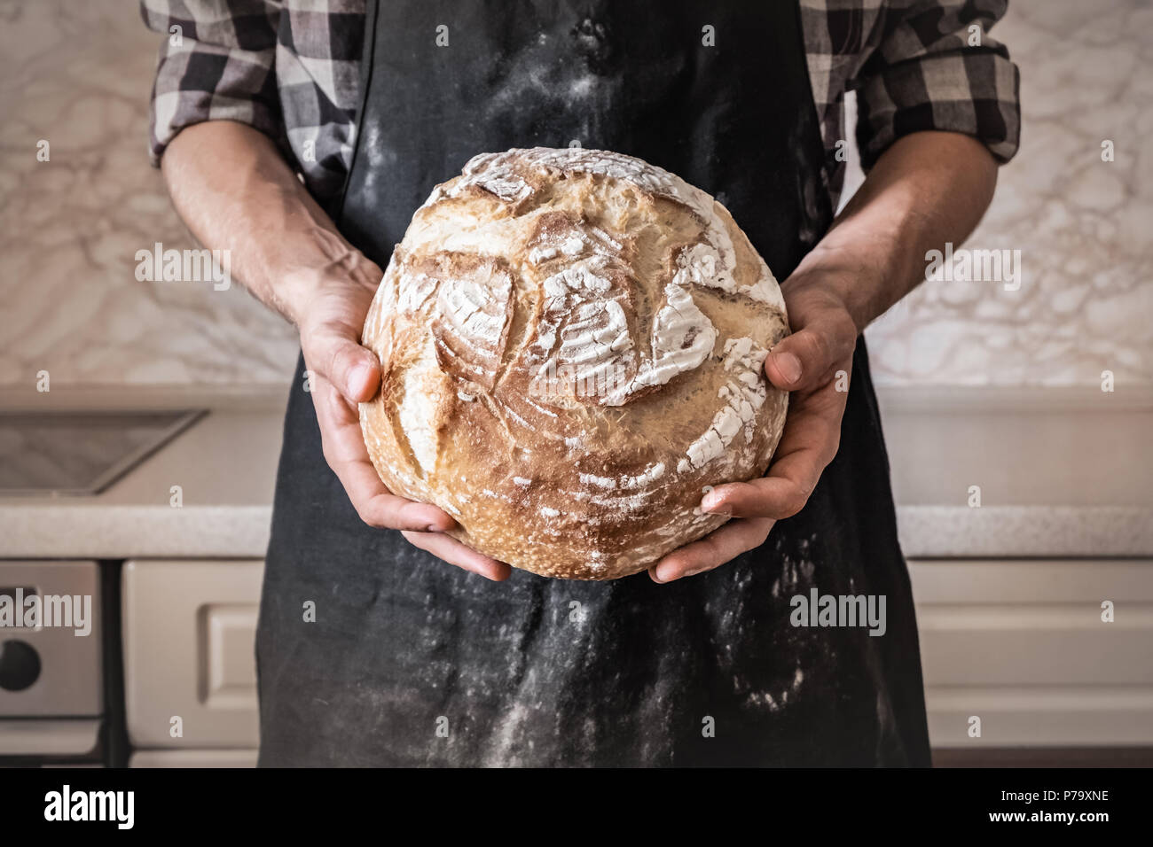 Hands of man holding big loaf of white bread Stock Photo - Alamy