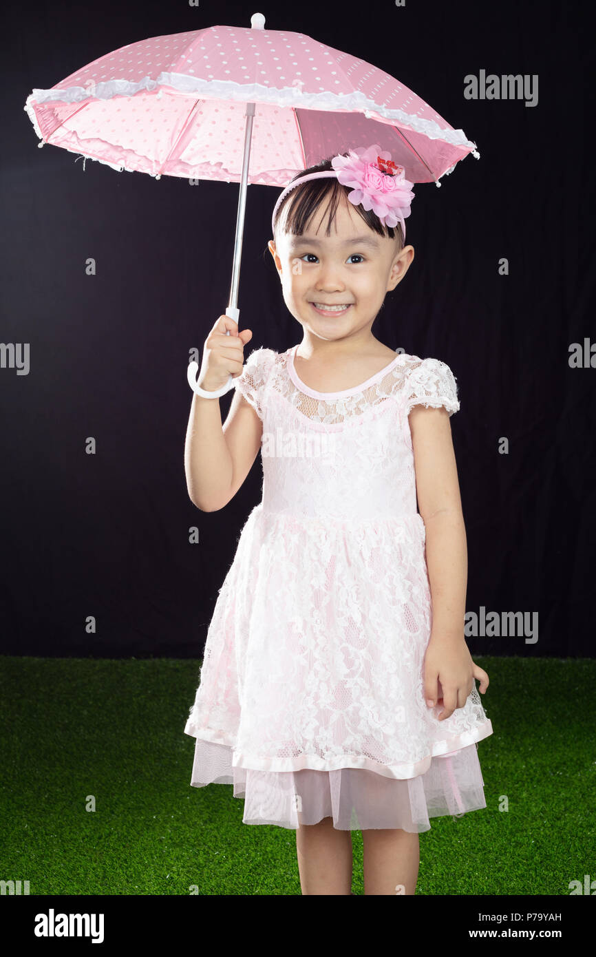 Asian Little Chinese Girl playing with umbrella outdoor Stock Photo - Alamy