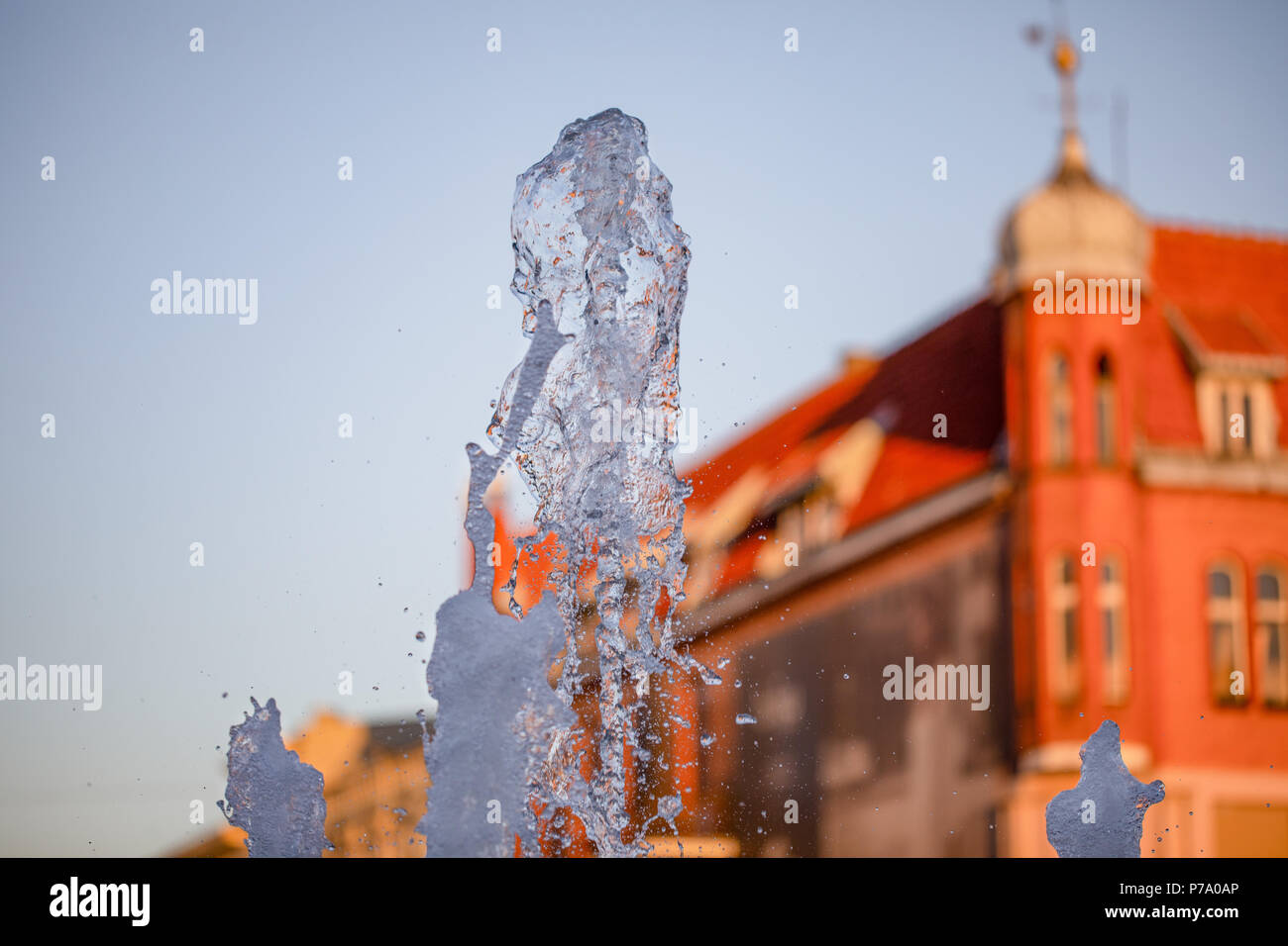 Fountain spurt, water drops, main street in the city as a background ...