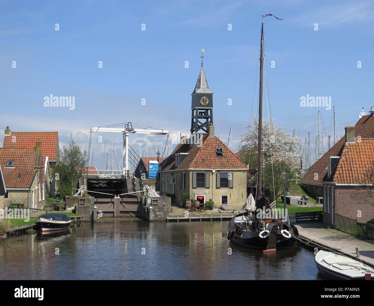 Wide canal with Church and Lift Bridge in Dutch fishing village Stock ...