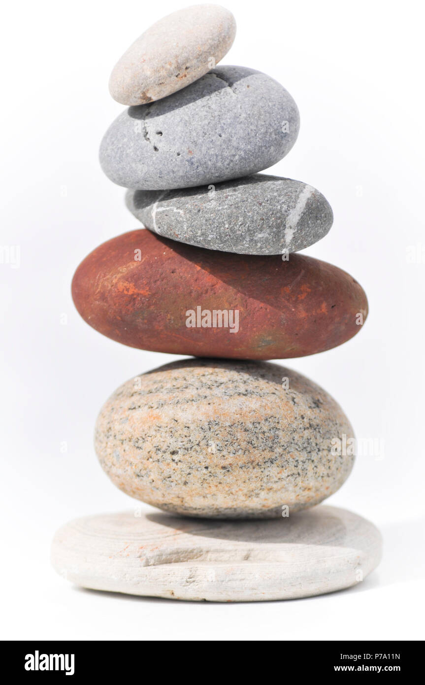 Six stones balancing on each other to create a tower of stones. Image ...