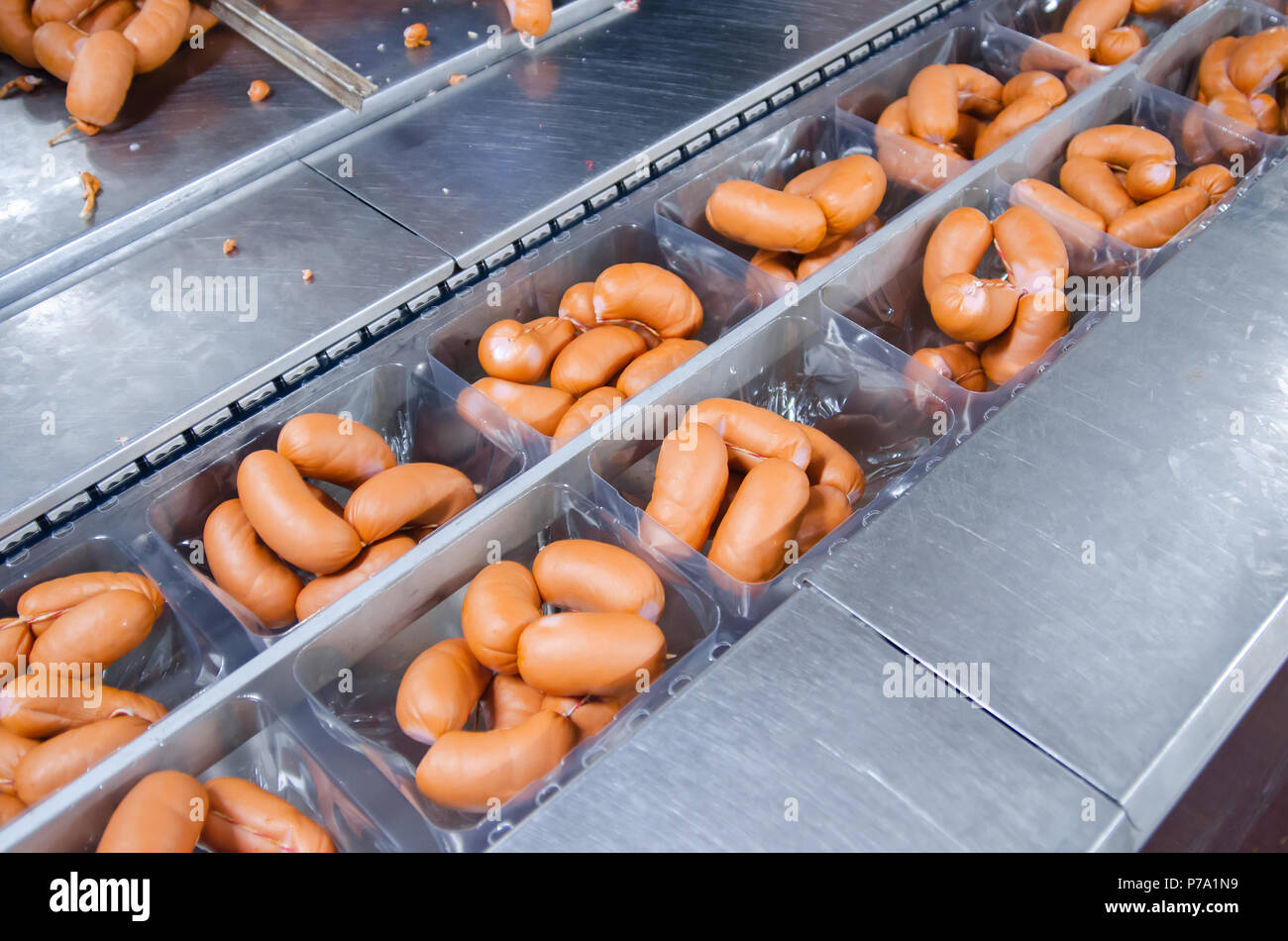 Sausages. Packing line of sausage. Industrial manufacture of sausage ...