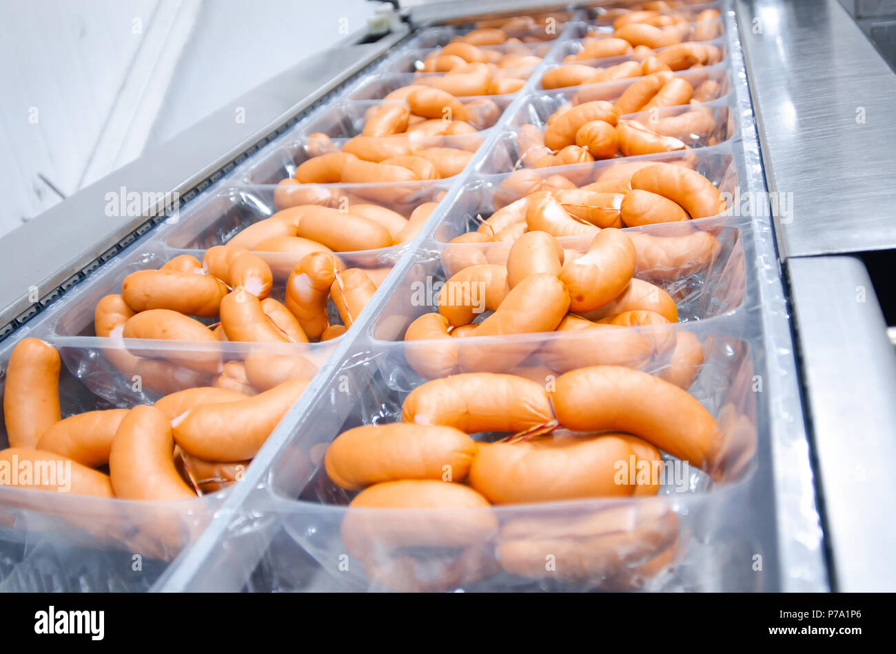 Sausages. Packing line of sausage. Industrial manufacture of sausage ...