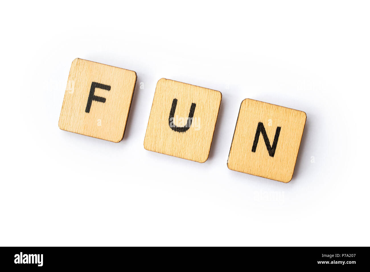 The word FUN spelt out with wooden lettered tiles Stock Photo - Alamy
