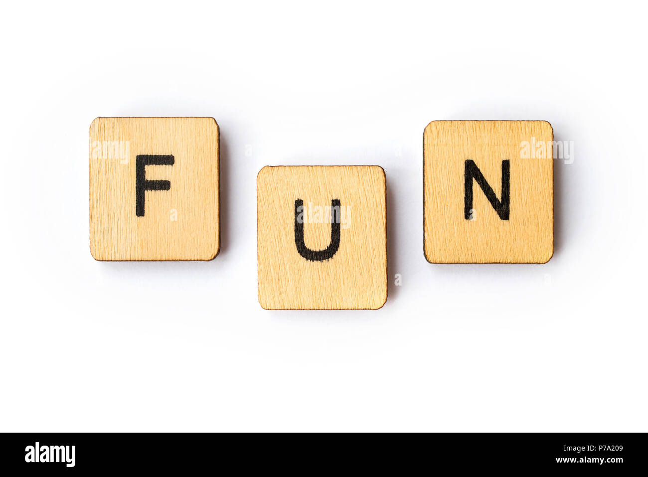 The word FUN spelt out with wooden lettered tiles Stock Photo - Alamy