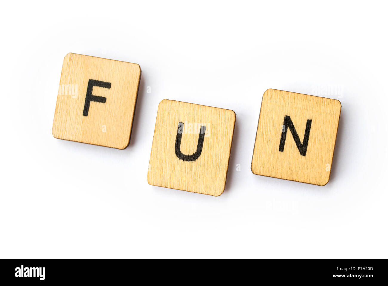 The word FUN spelt out with wooden lettered tiles Stock Photo - Alamy